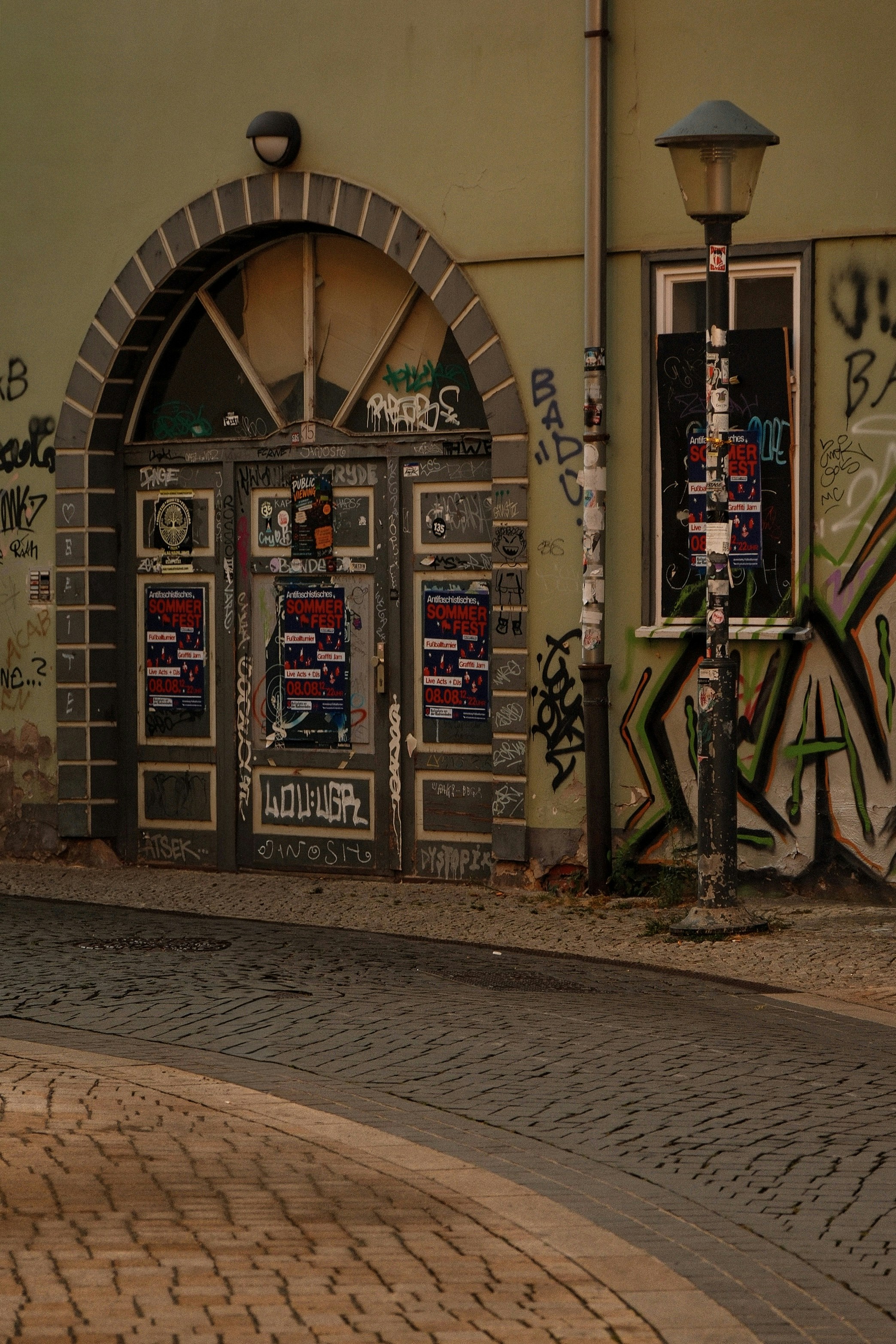 Urban Doorway and Graffiti Arch at Dusk