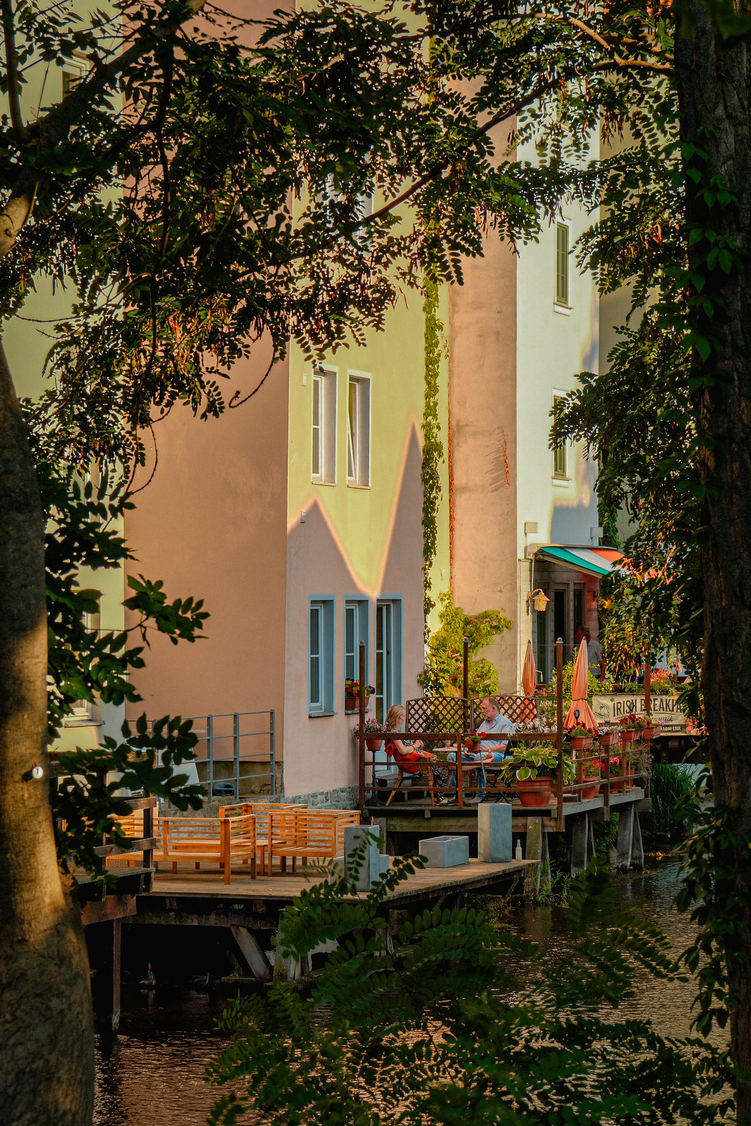 Pastel canal cafe with shaded courtyard