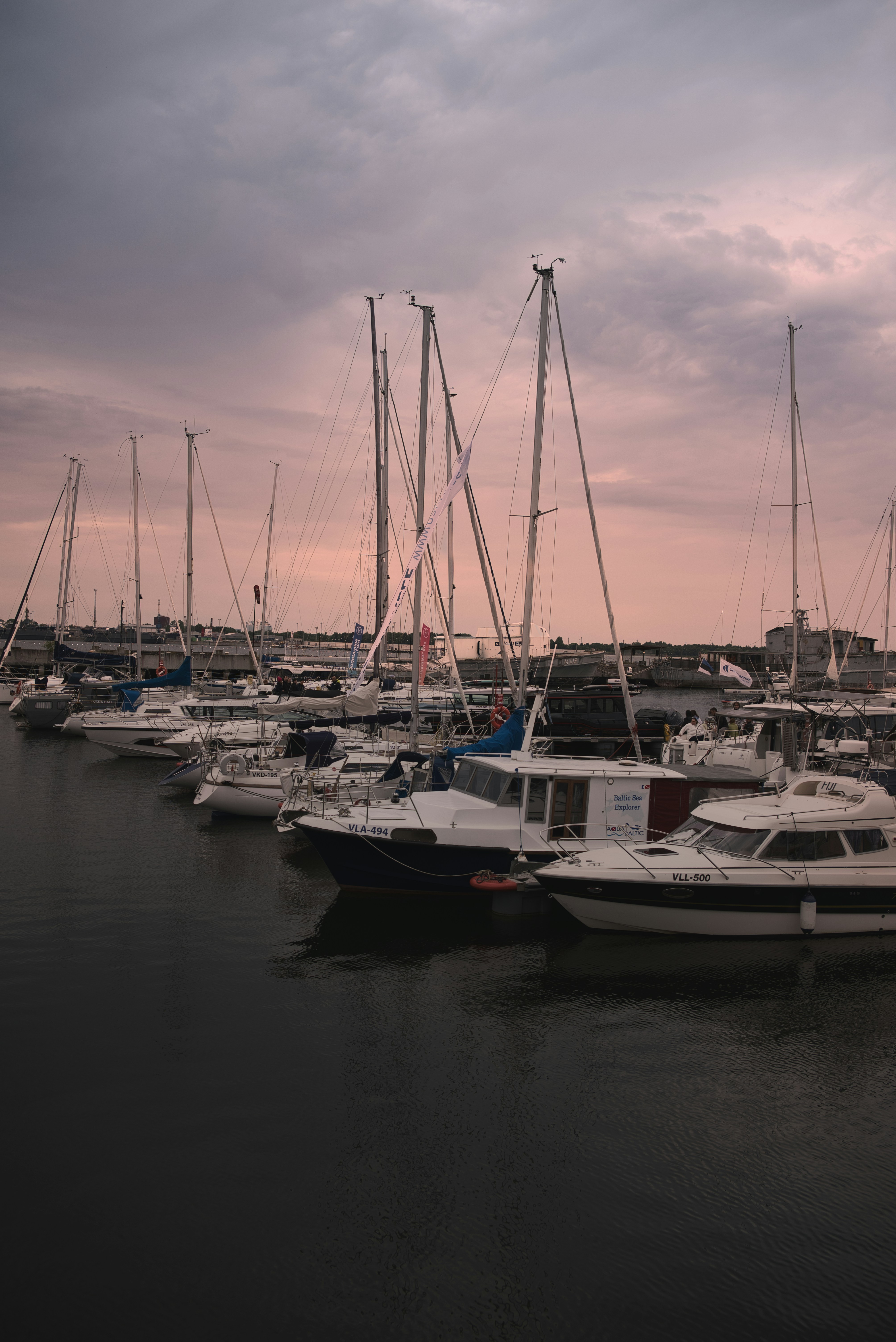 Moorings at Dusk: A Quiet Fleet Bordered by Still Water