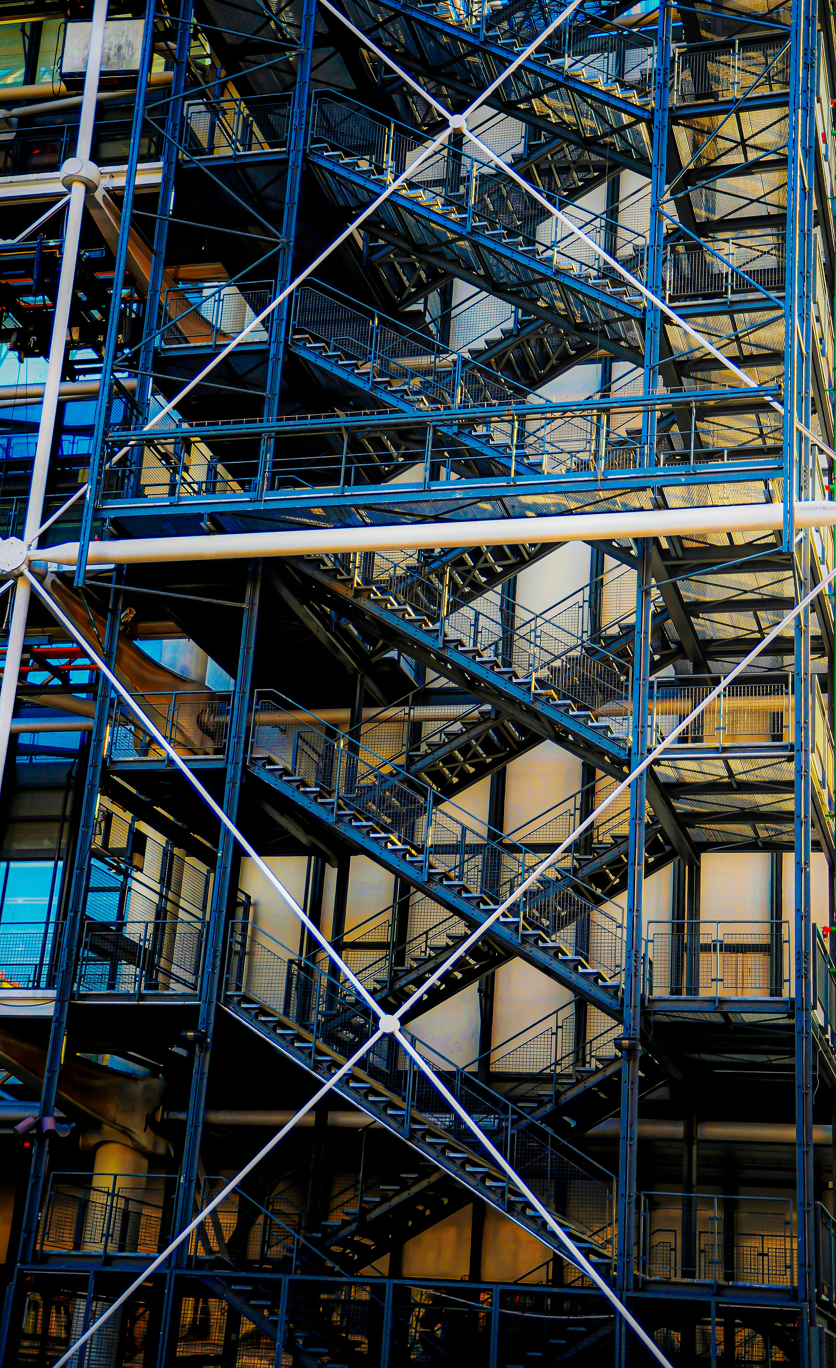 Crisscross of blue steel: a façade of stairwells and girders