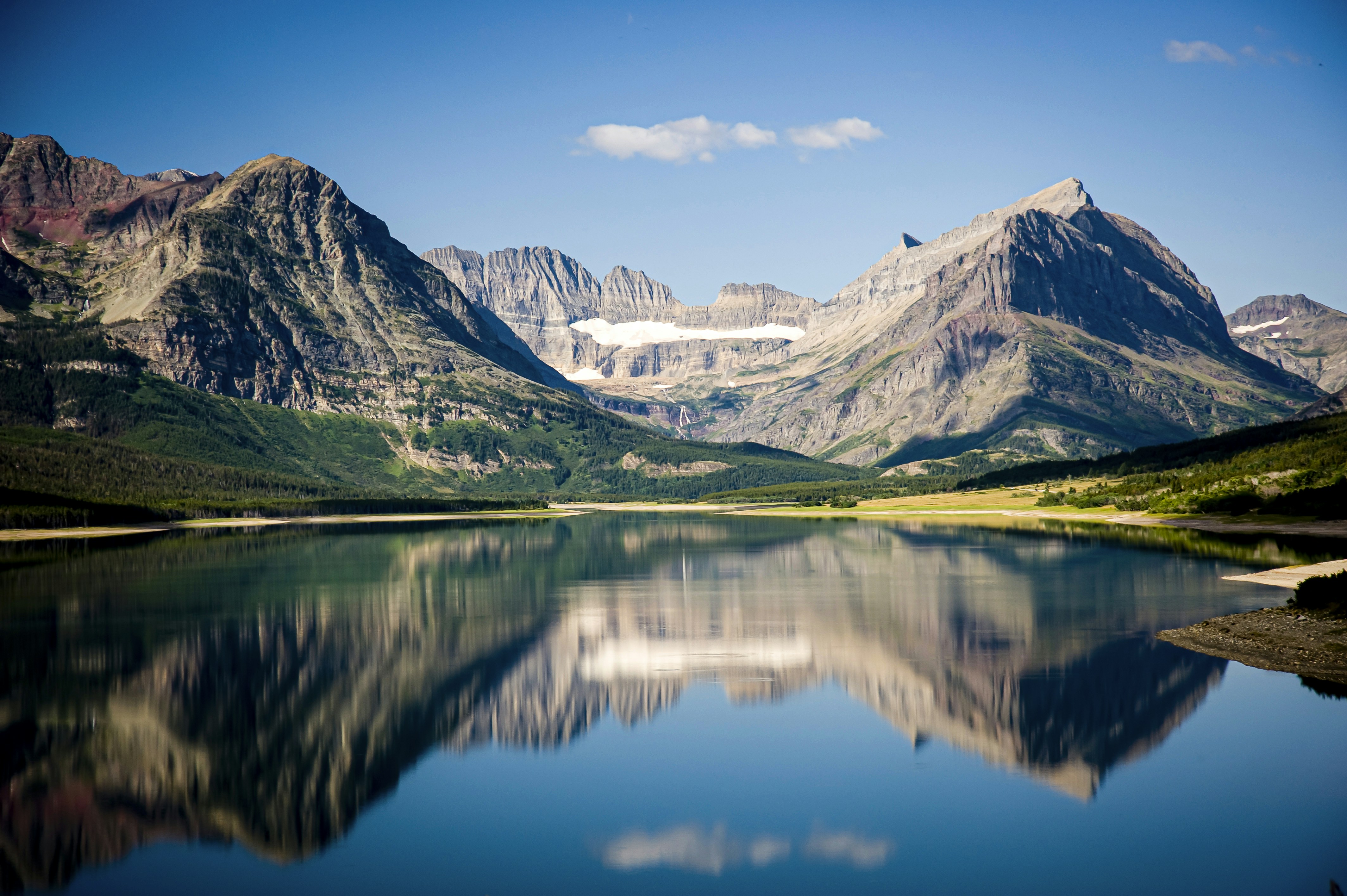 Glacial Mirror: Dawning Peaks Reflect in Alpine Stillness