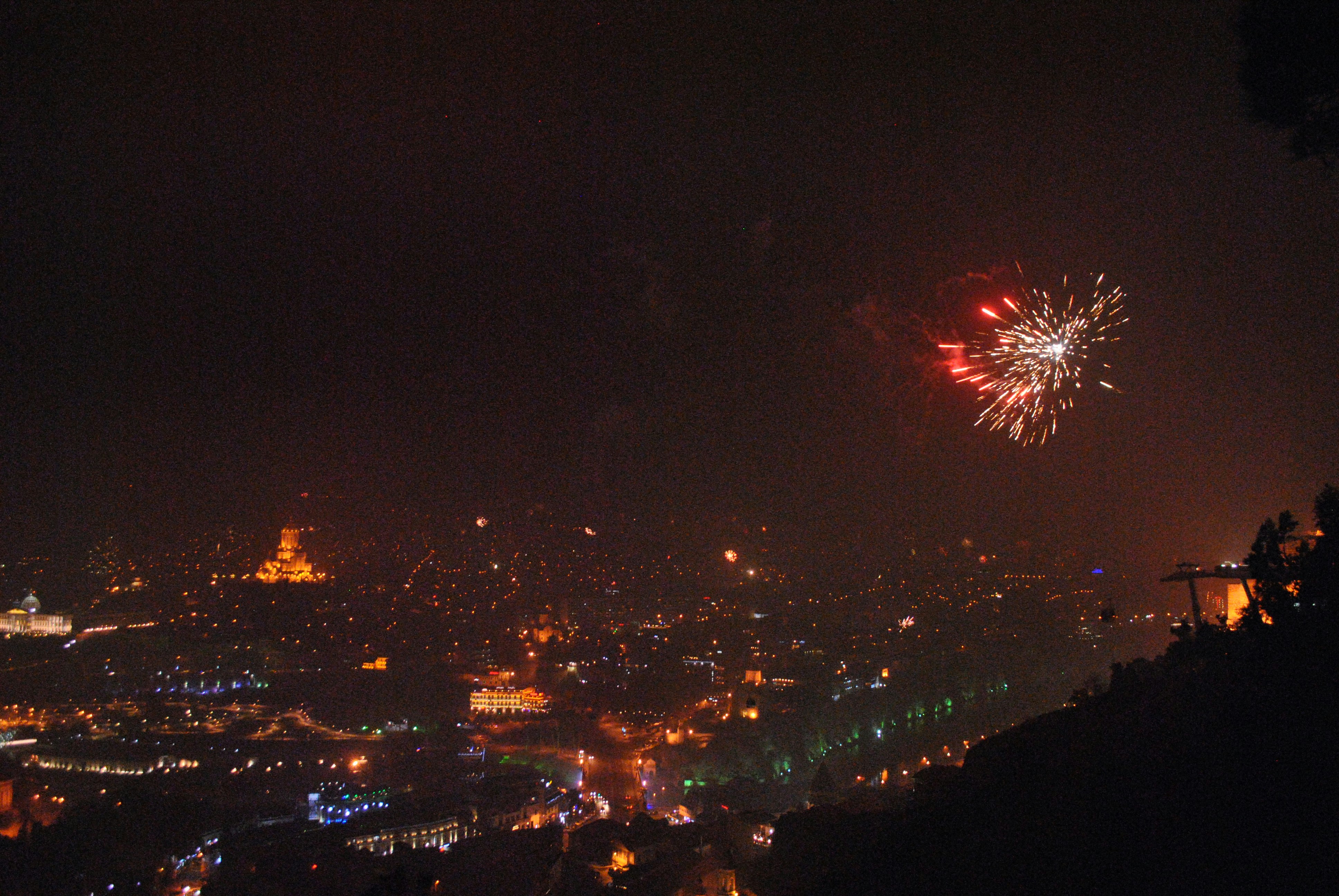 Fireworks over a Lantern-Soft Capital: Nightscape of a Twilight City