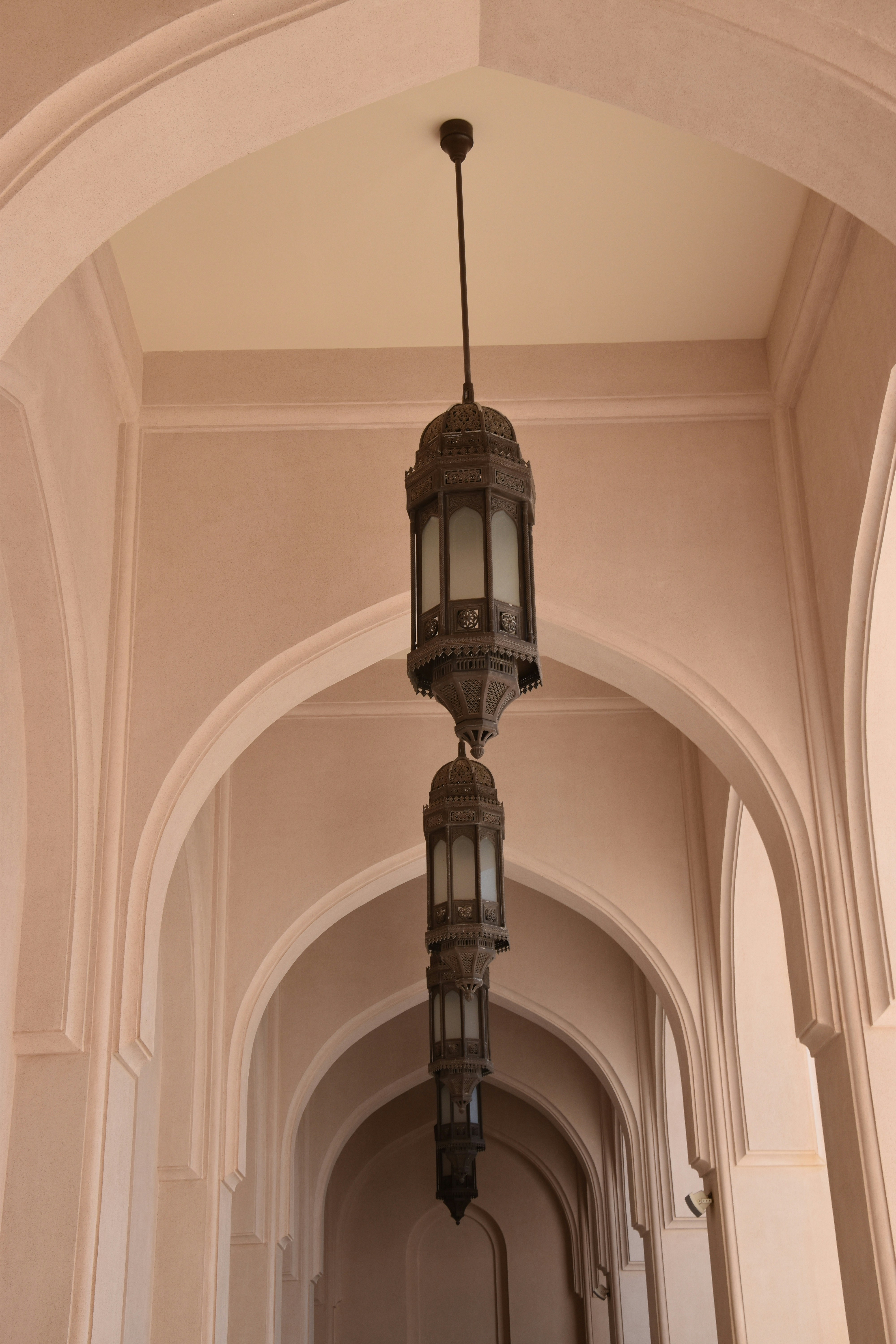 Suspended Lanterns in an Archway Corridor