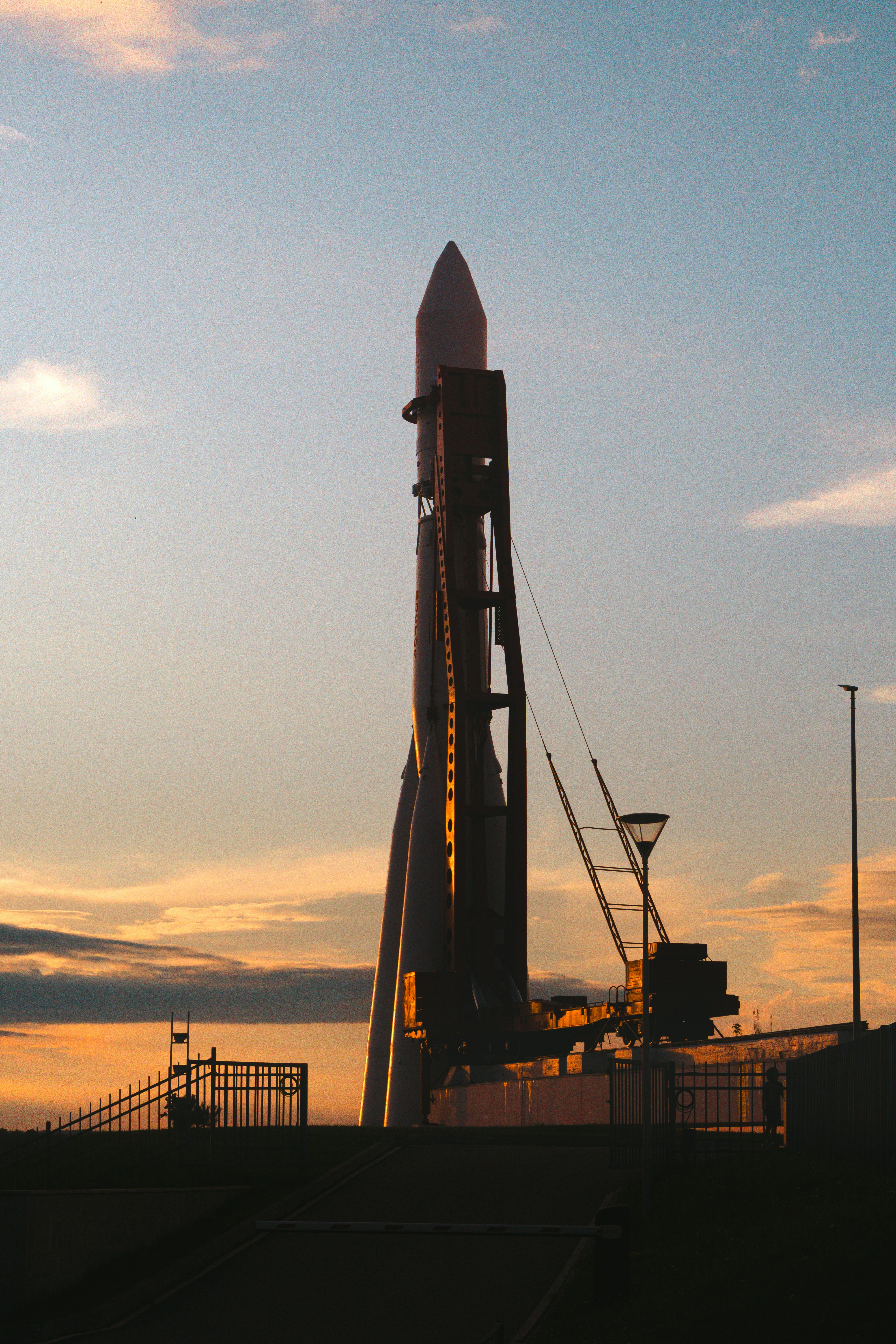 Lift-off at Dusk: A Rocket Emerges Against a Golden Horizon
