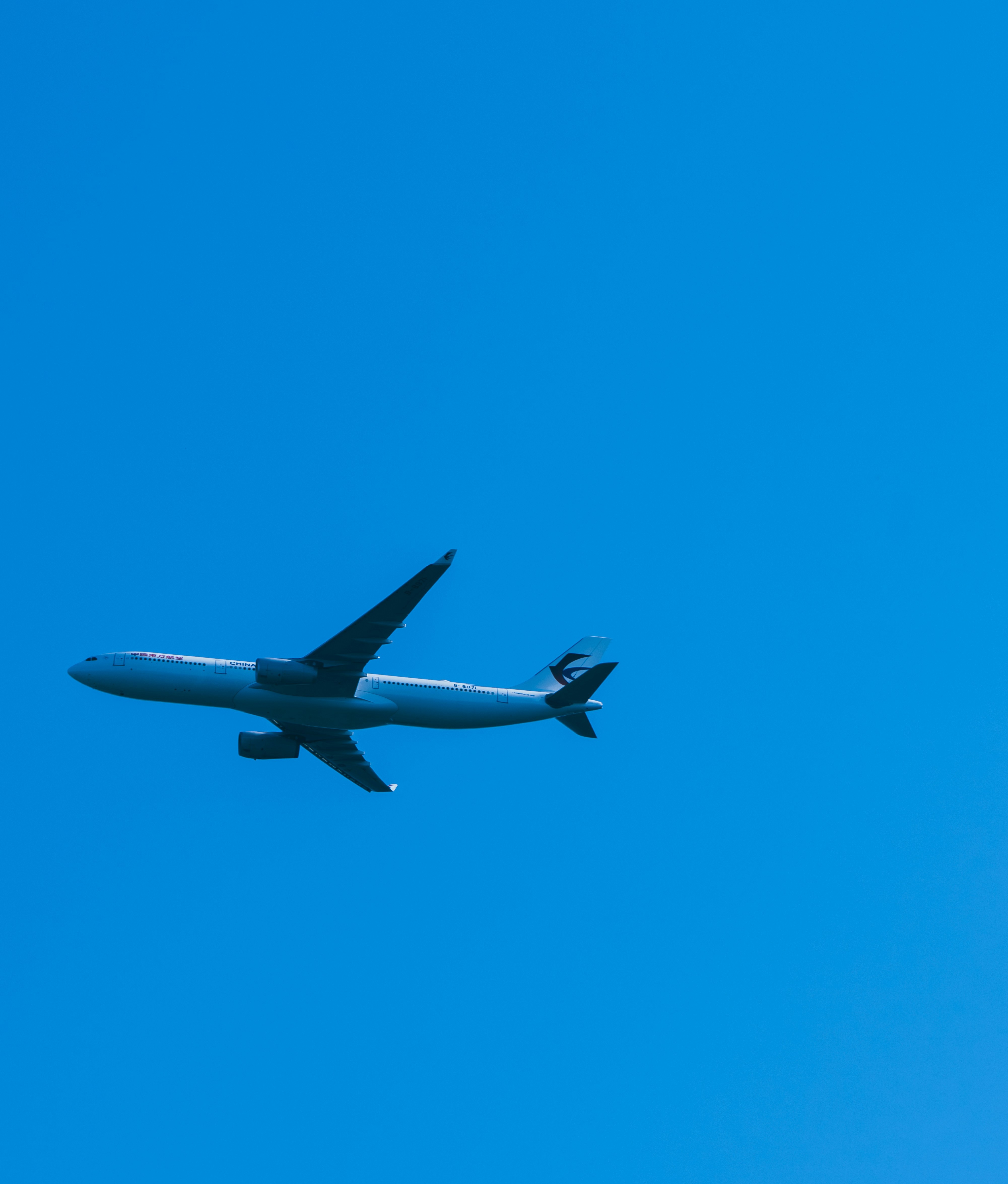 High-Altitude Freighter: A Boeing-like silhouette against a pristine blue