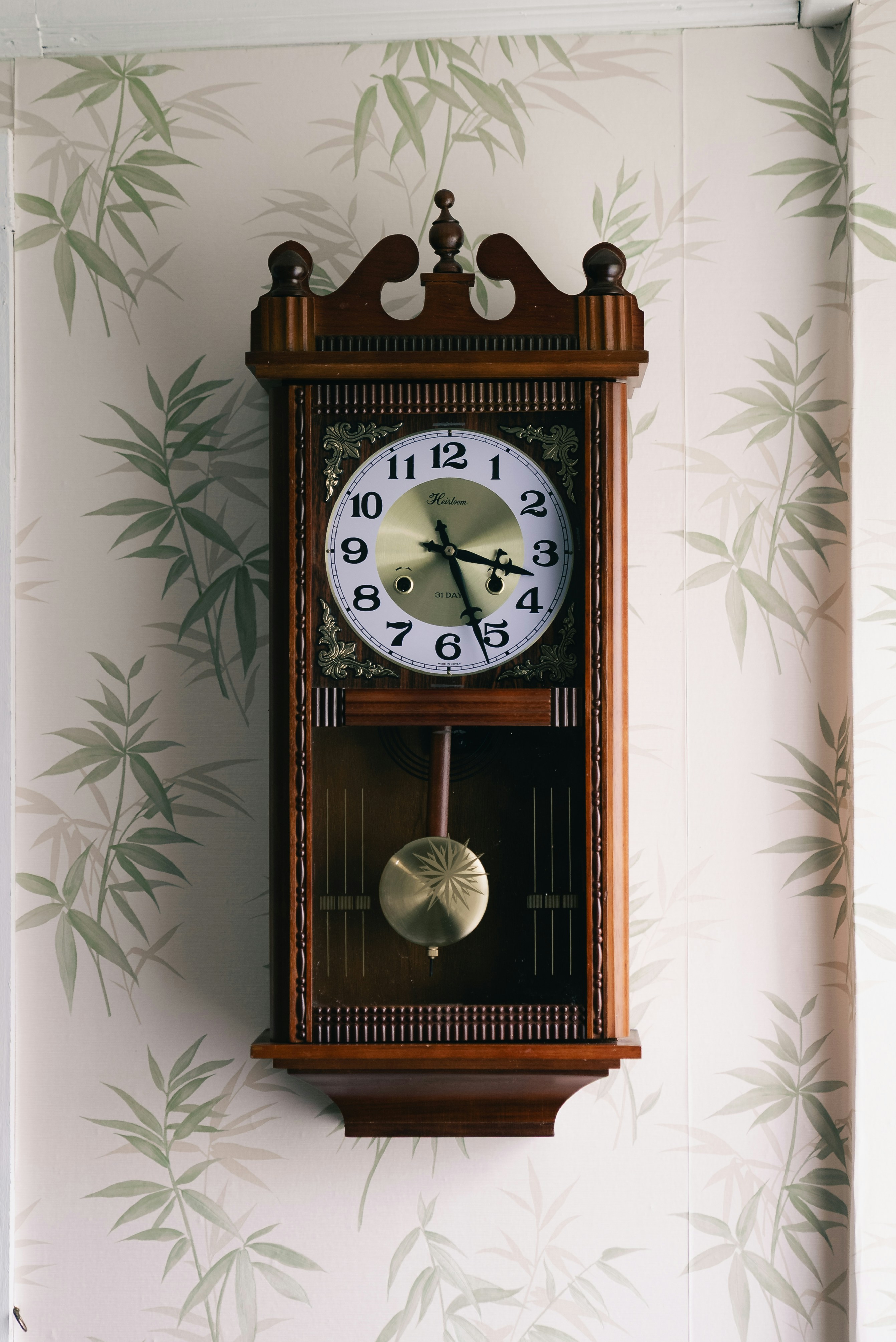 Ticking Heritage: An Antique Wall Clock in a Pale-Leafed Room