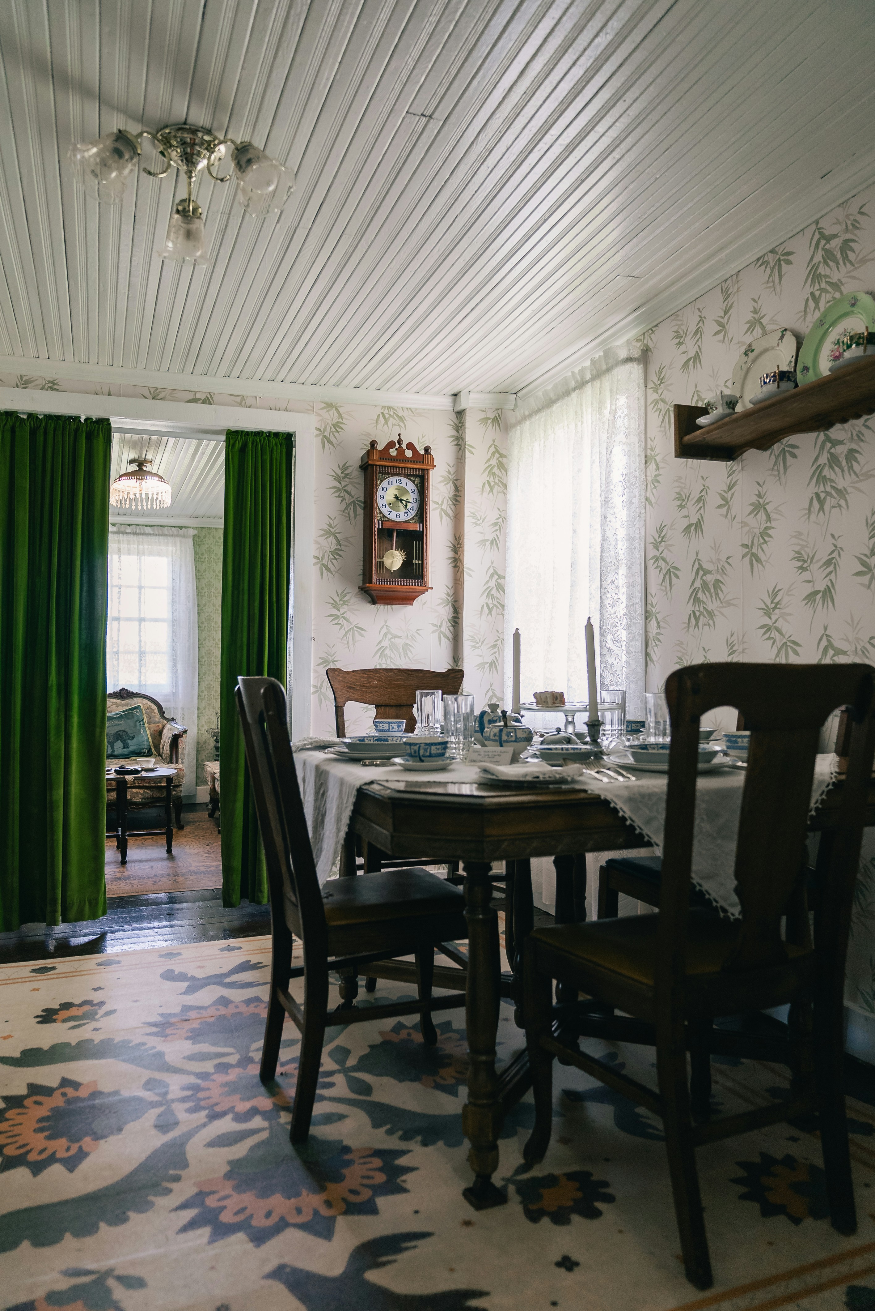 Vintage Dining Room: Green Velvet Curtains Framing a Timeless Table Scene