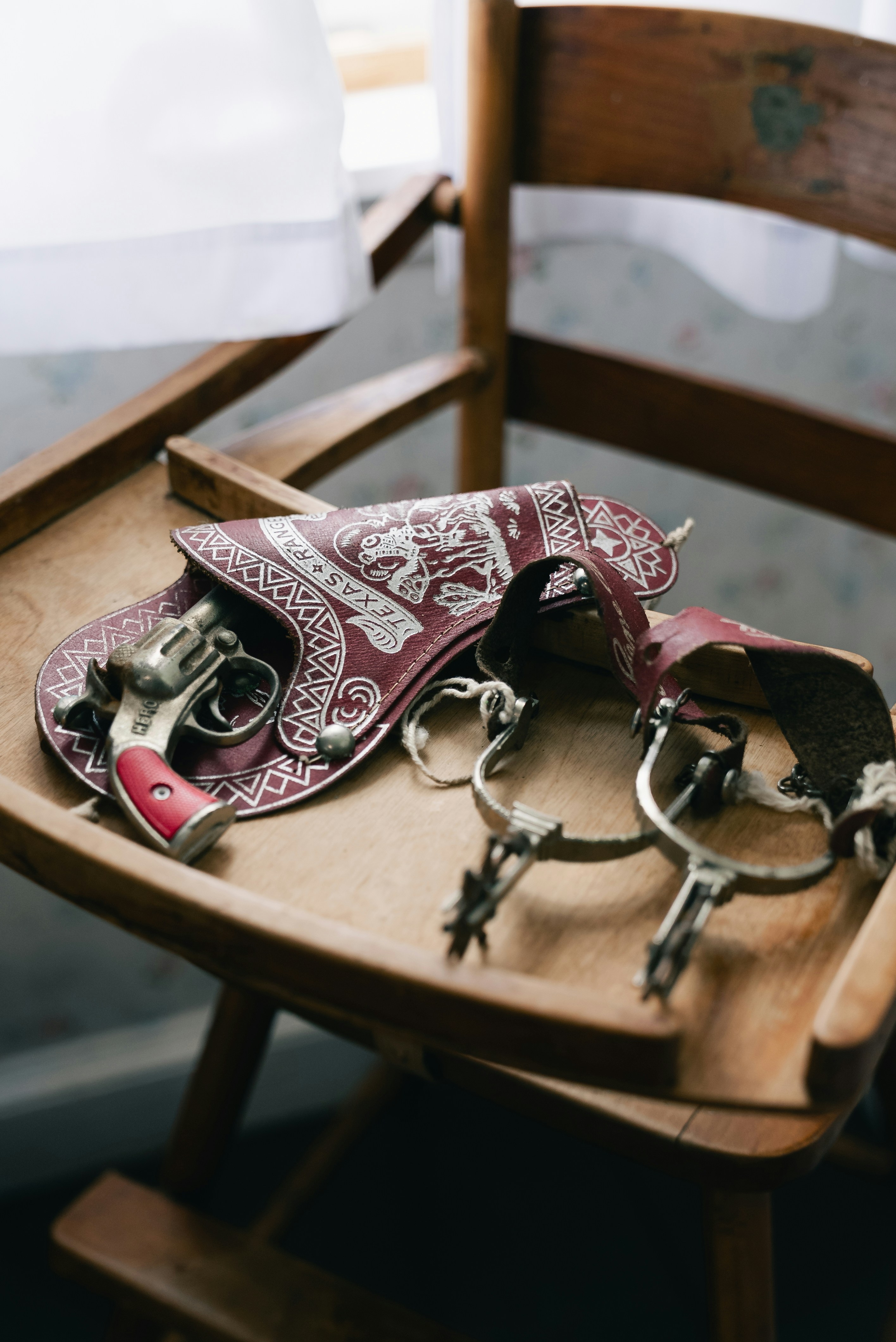 Saddle Leather and Silver: A Calm Moment with Western Tack on a Wooden Chair