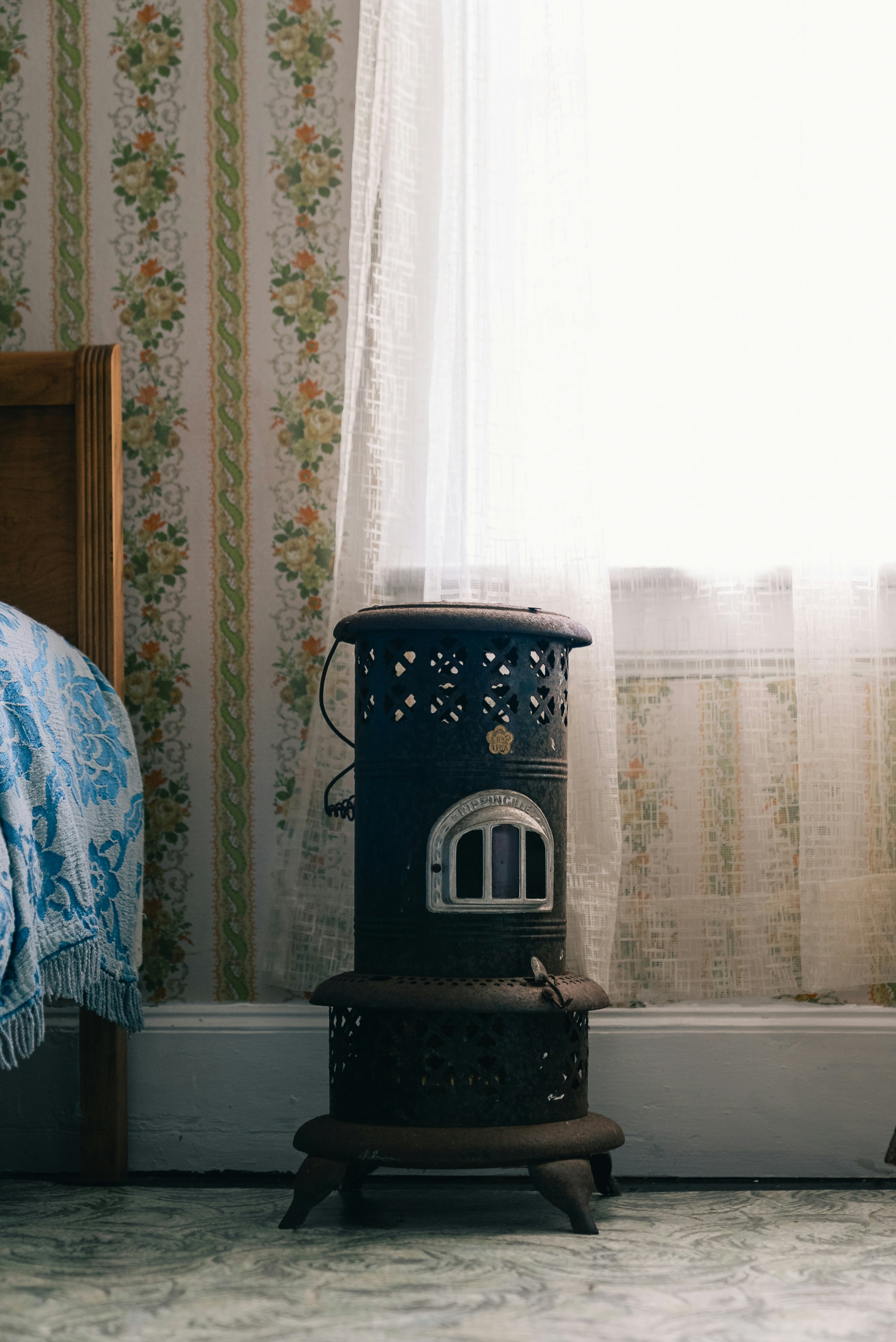Cozy corner heat: vintage heater against sunlit lace