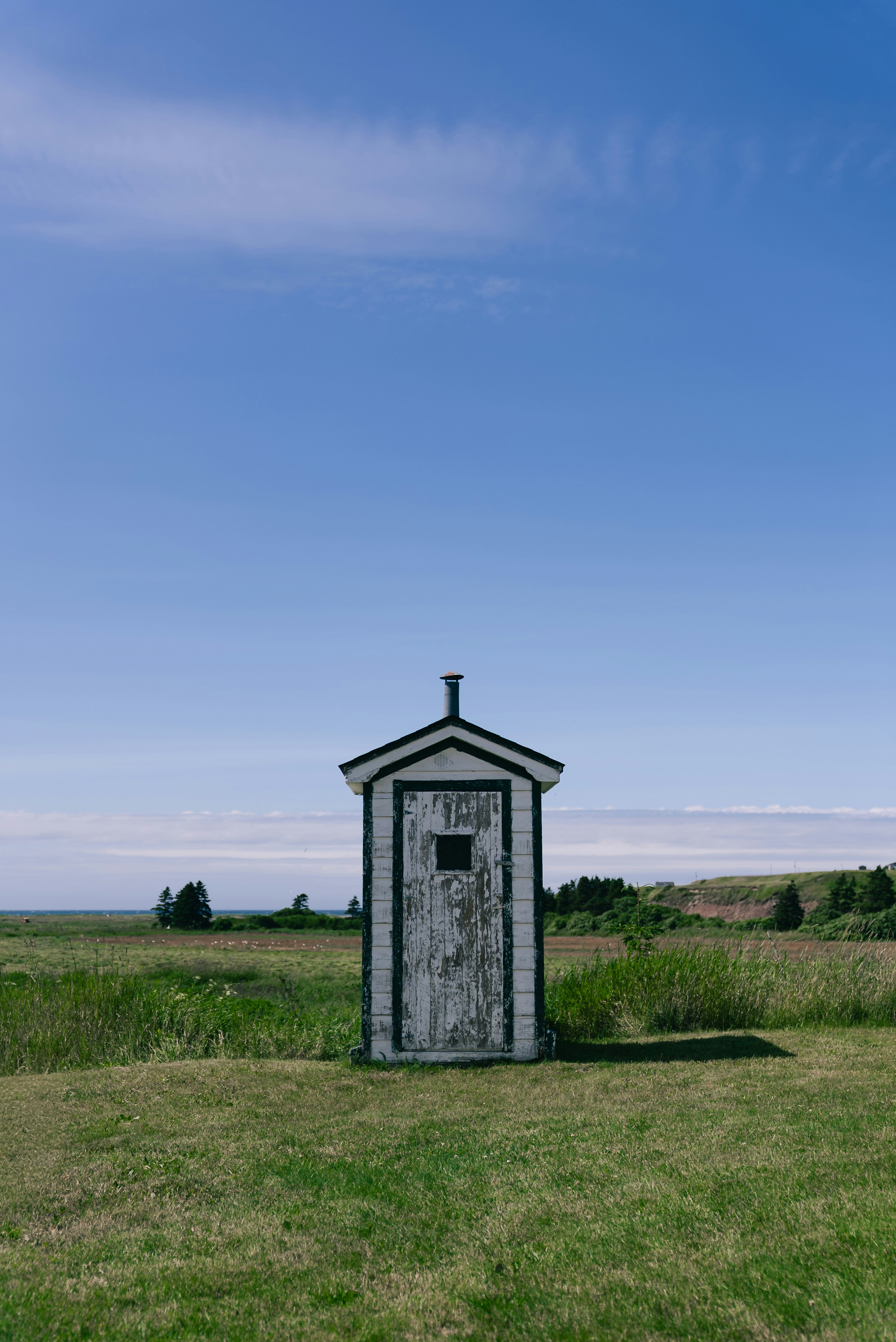 Weathered Shack Stands Against Open Horizon