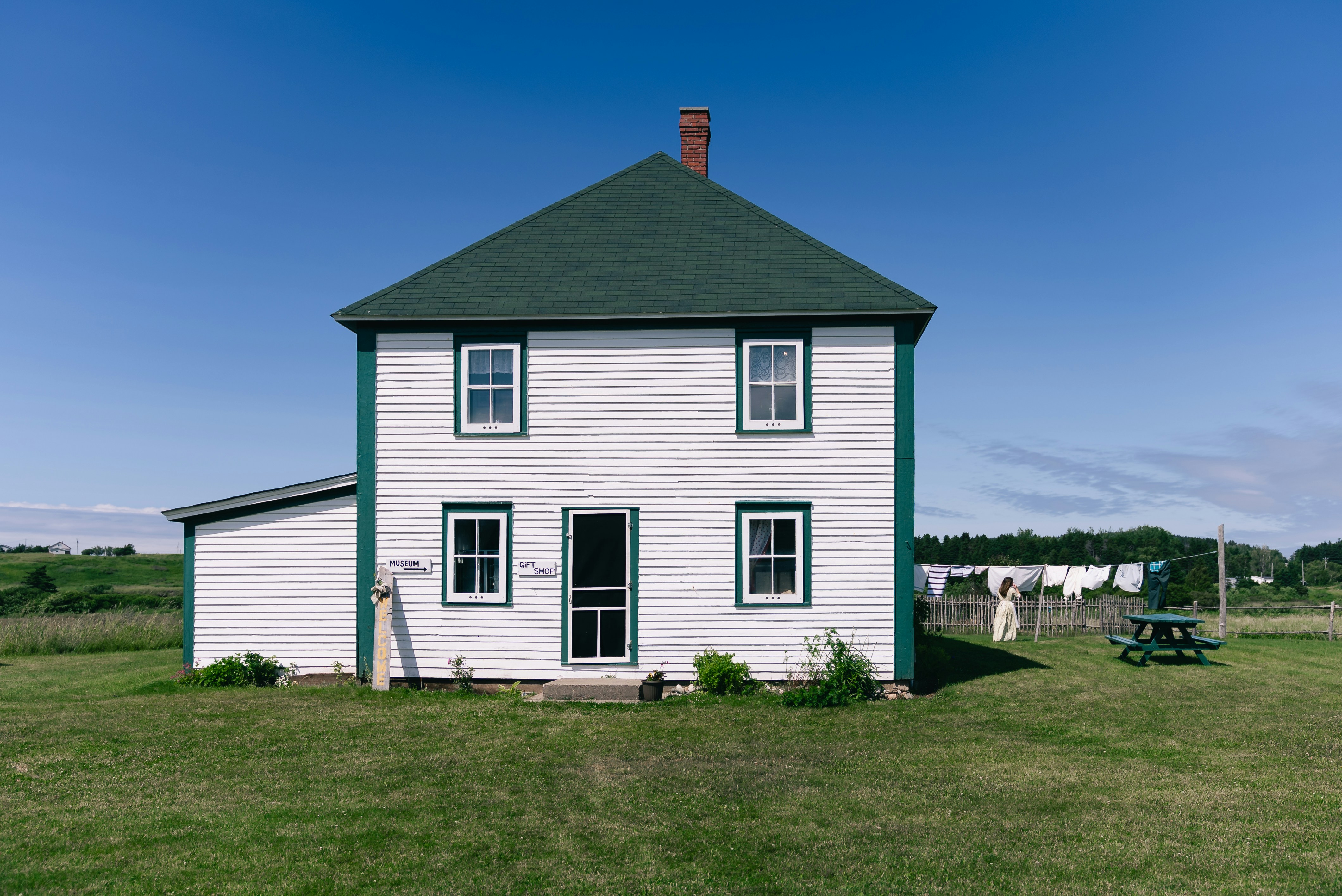 White Farmhouse on a Crest of Green