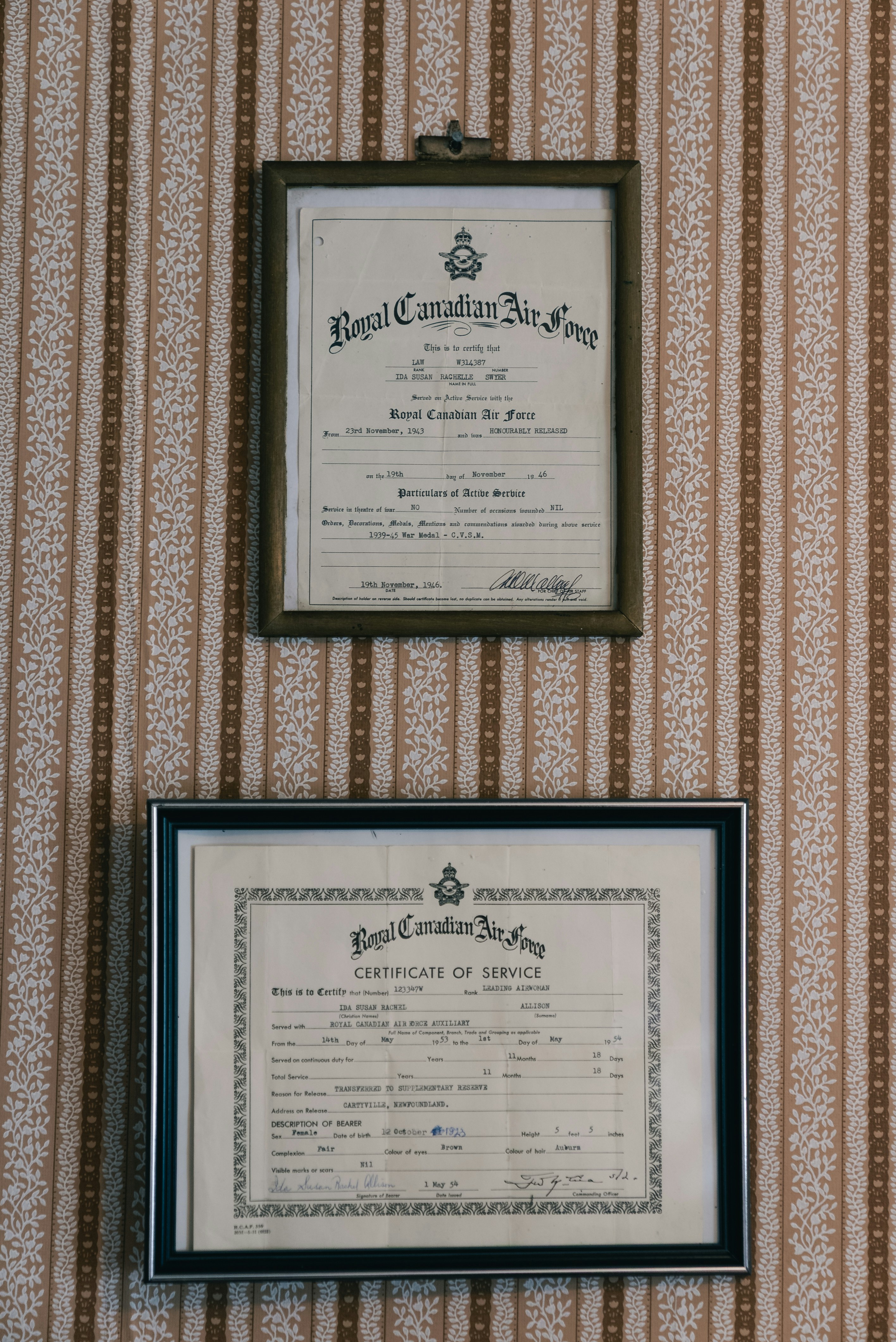 Framed Certificates: Royal Canadian Air Force Documents Adorning Vintage Wall