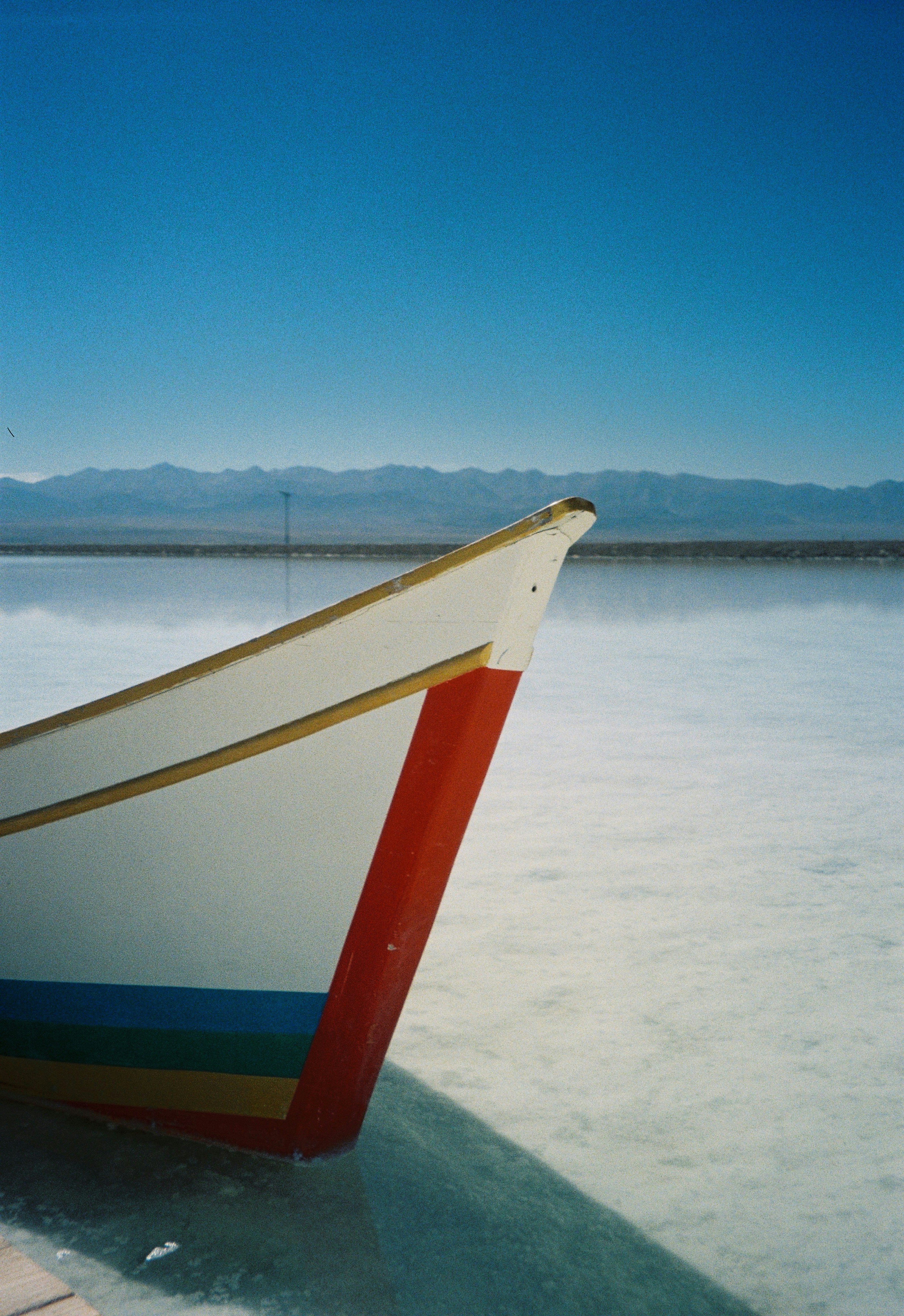 Bow of a Painted Boat Piercing Calm Waters
