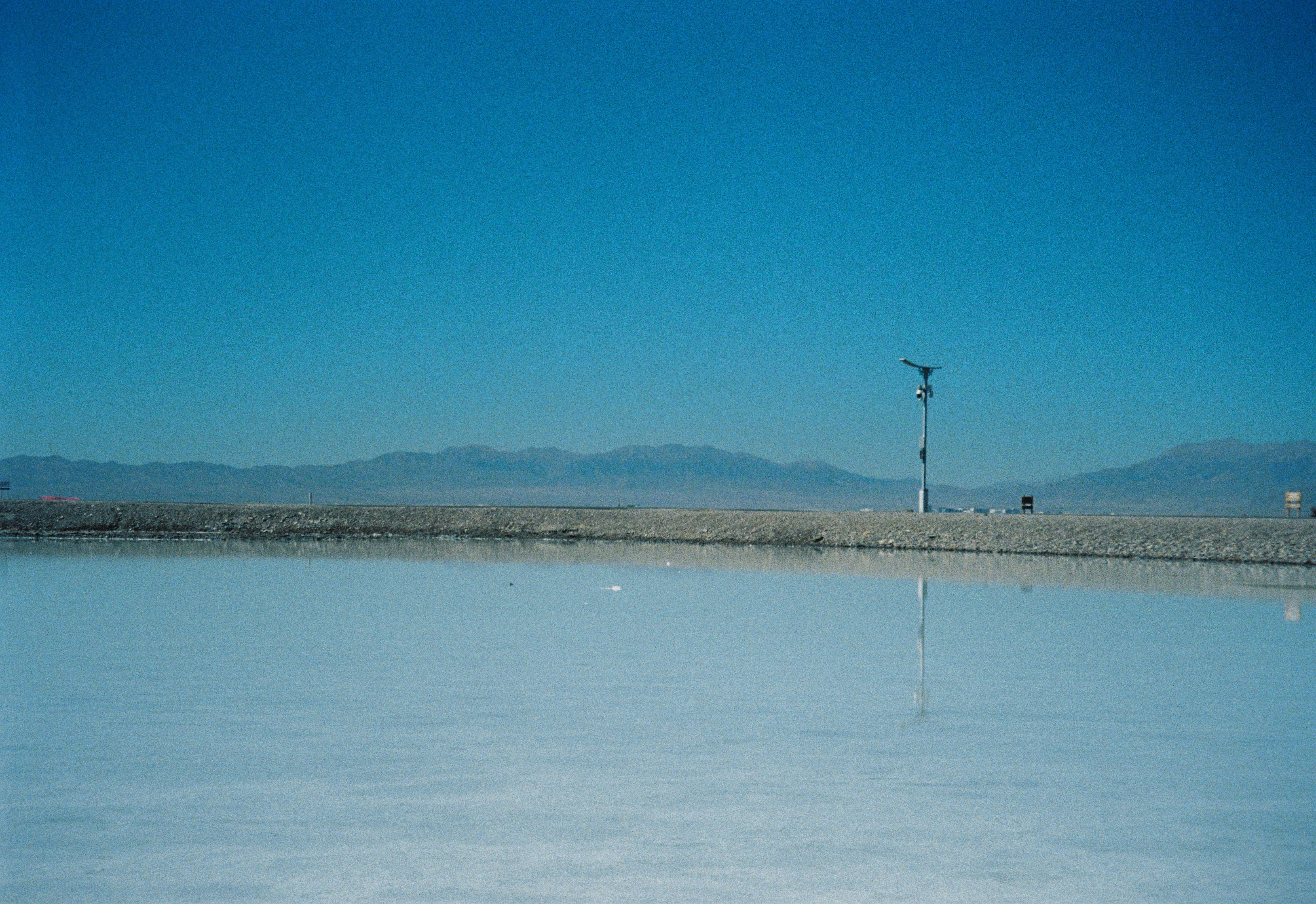 Midday Mirage: A Quiet Jetty and Twin Horizon