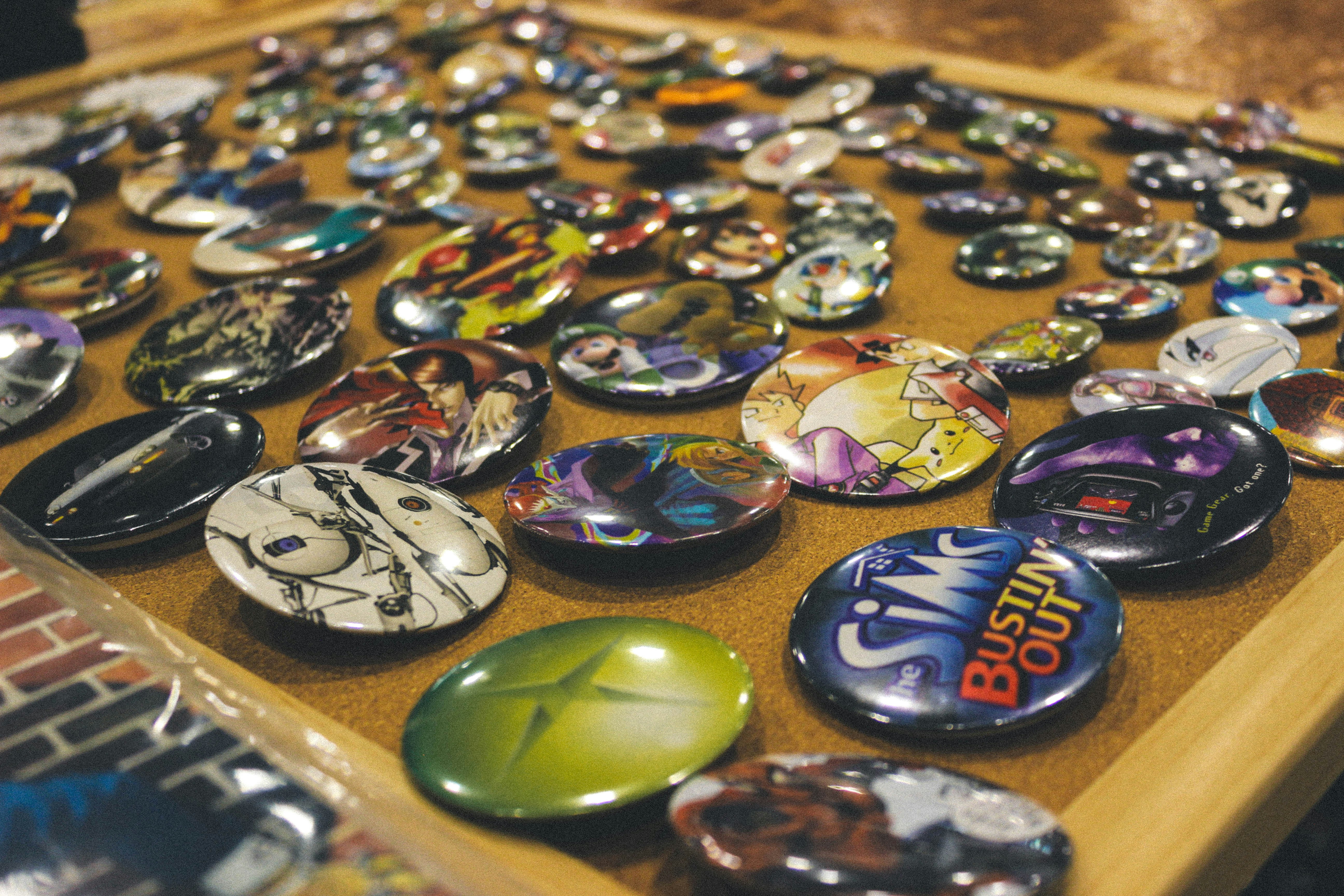Carousel of Badges: A Mess of Colorful Pins on a Wooden Display
