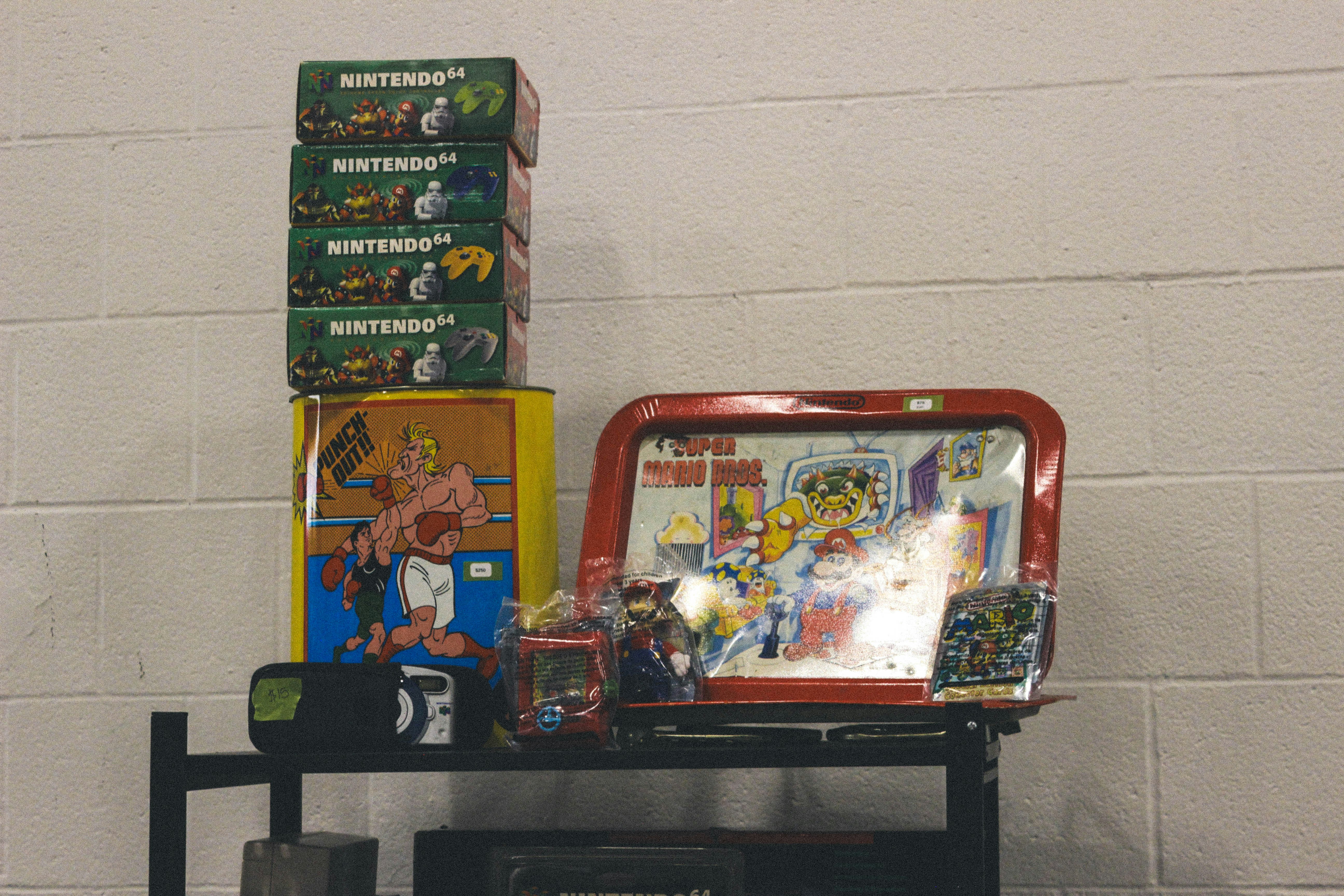 Shelf of Retro Toys: Stacked Nintendo Boxes and Classic Comics