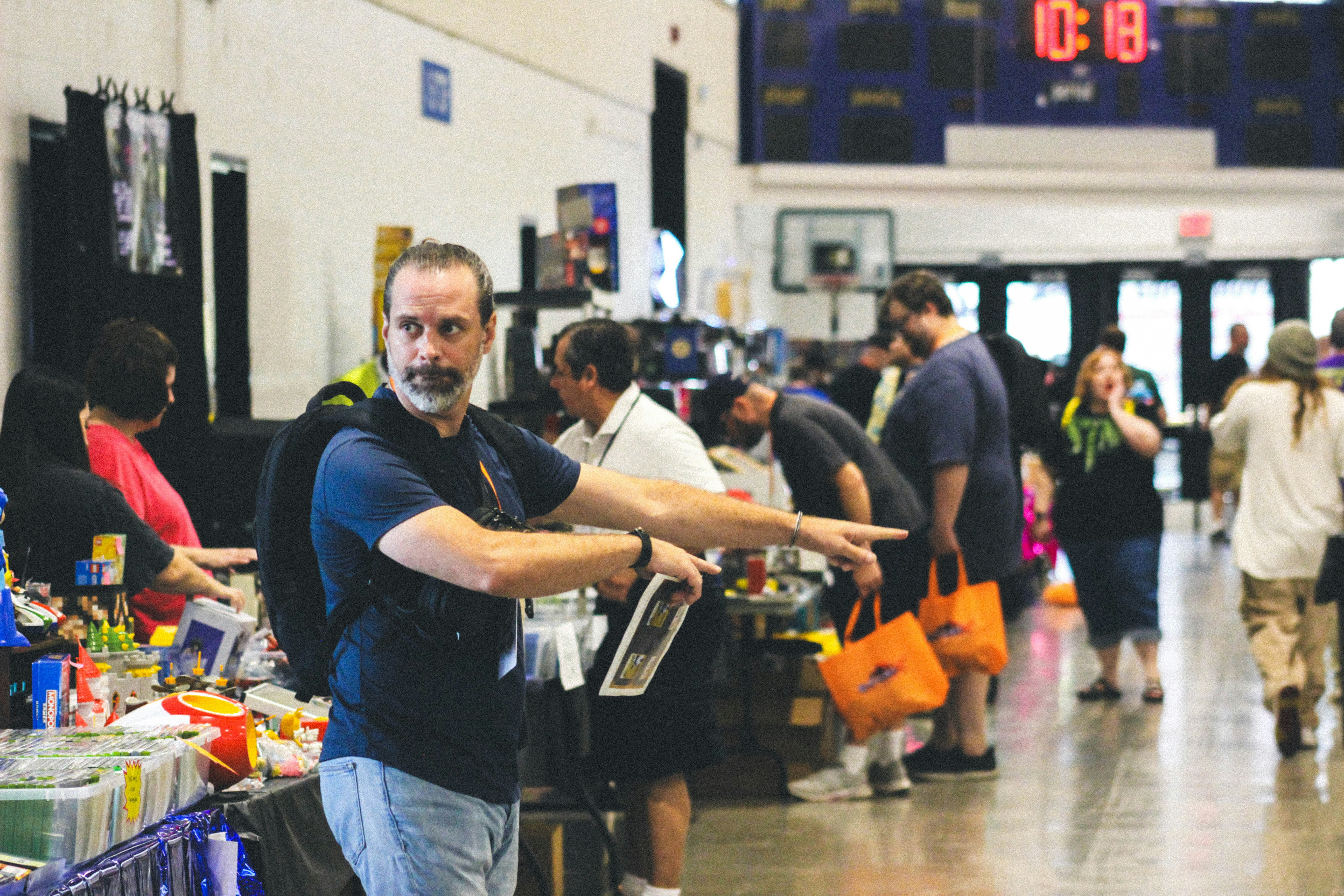 Mid-Conversation at the Expo: The Man with a Courtly Gesture