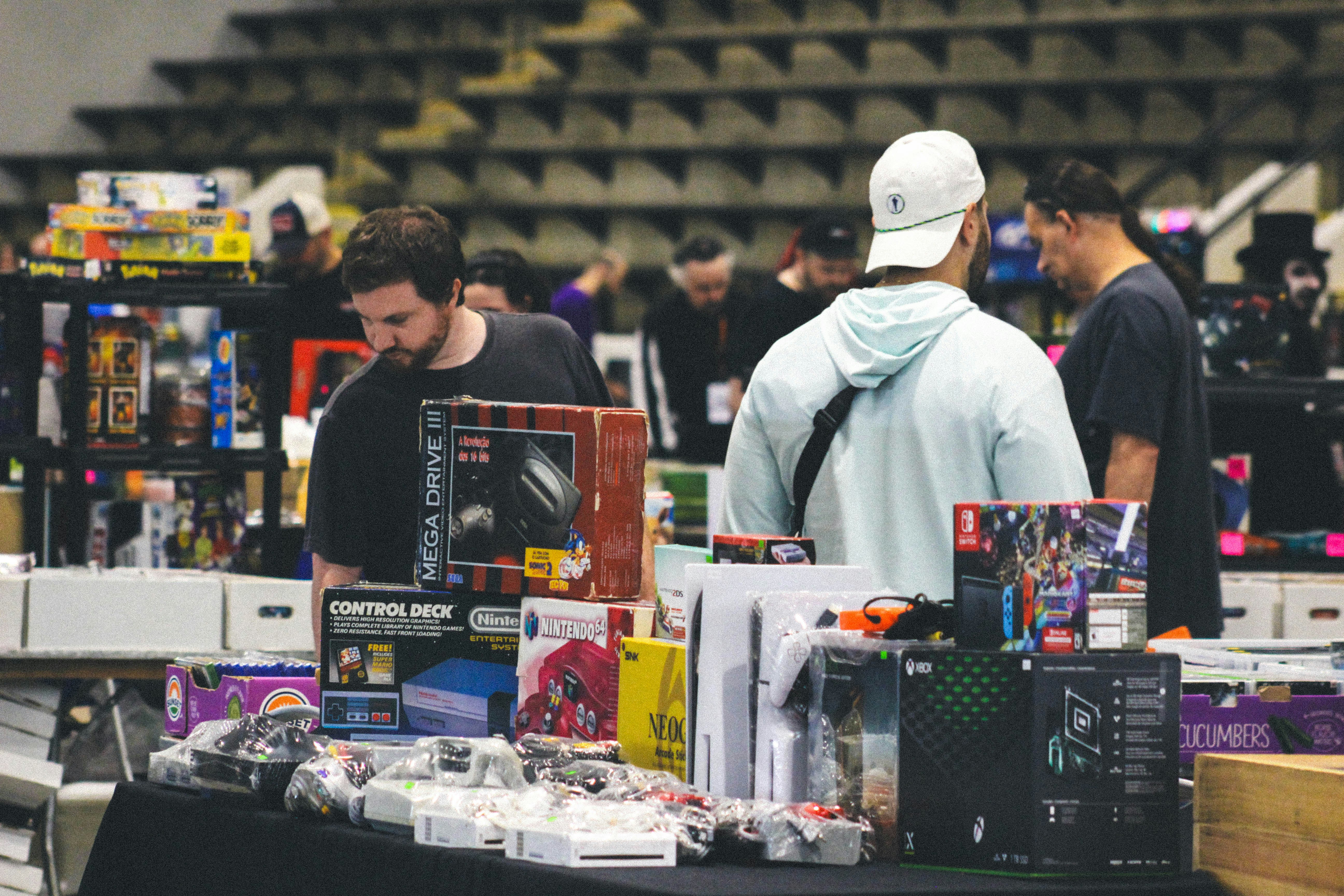 Vendor stall at a convention floor crowded with boxed electronics