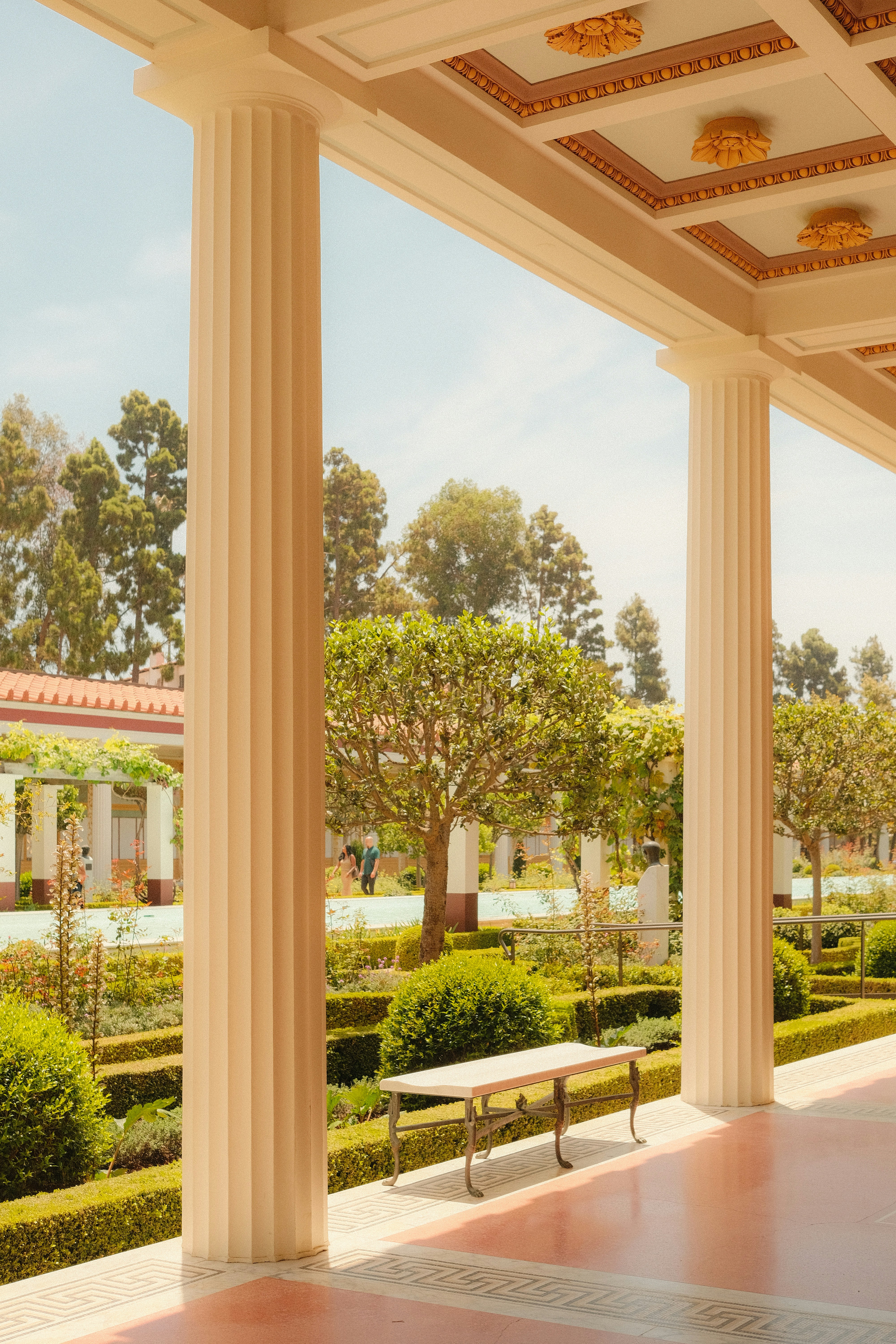 Sunlit Columns and Garden Vista in a Classical Courtyard