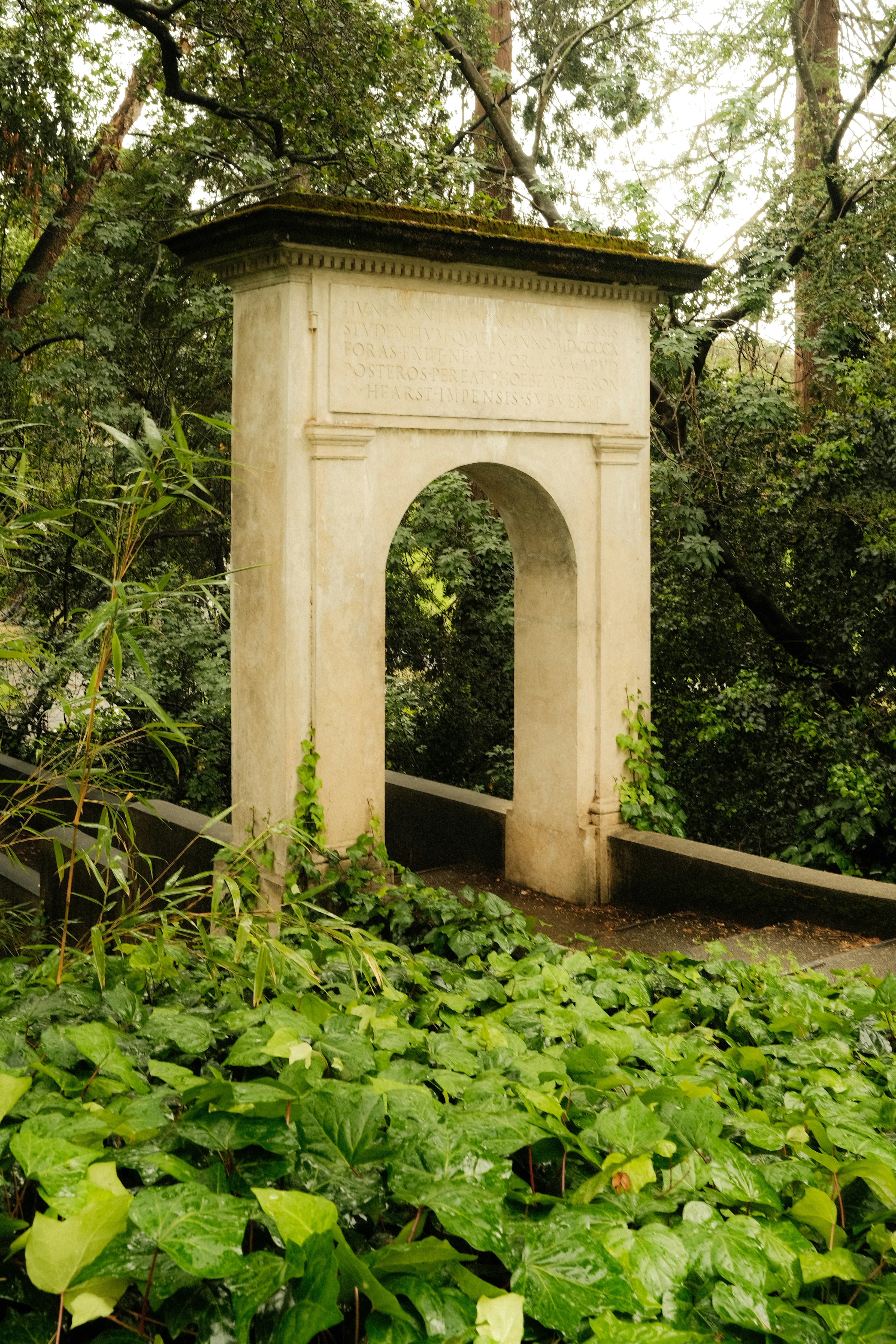 Archway in a leafy alcove: a mossy ritual of stone