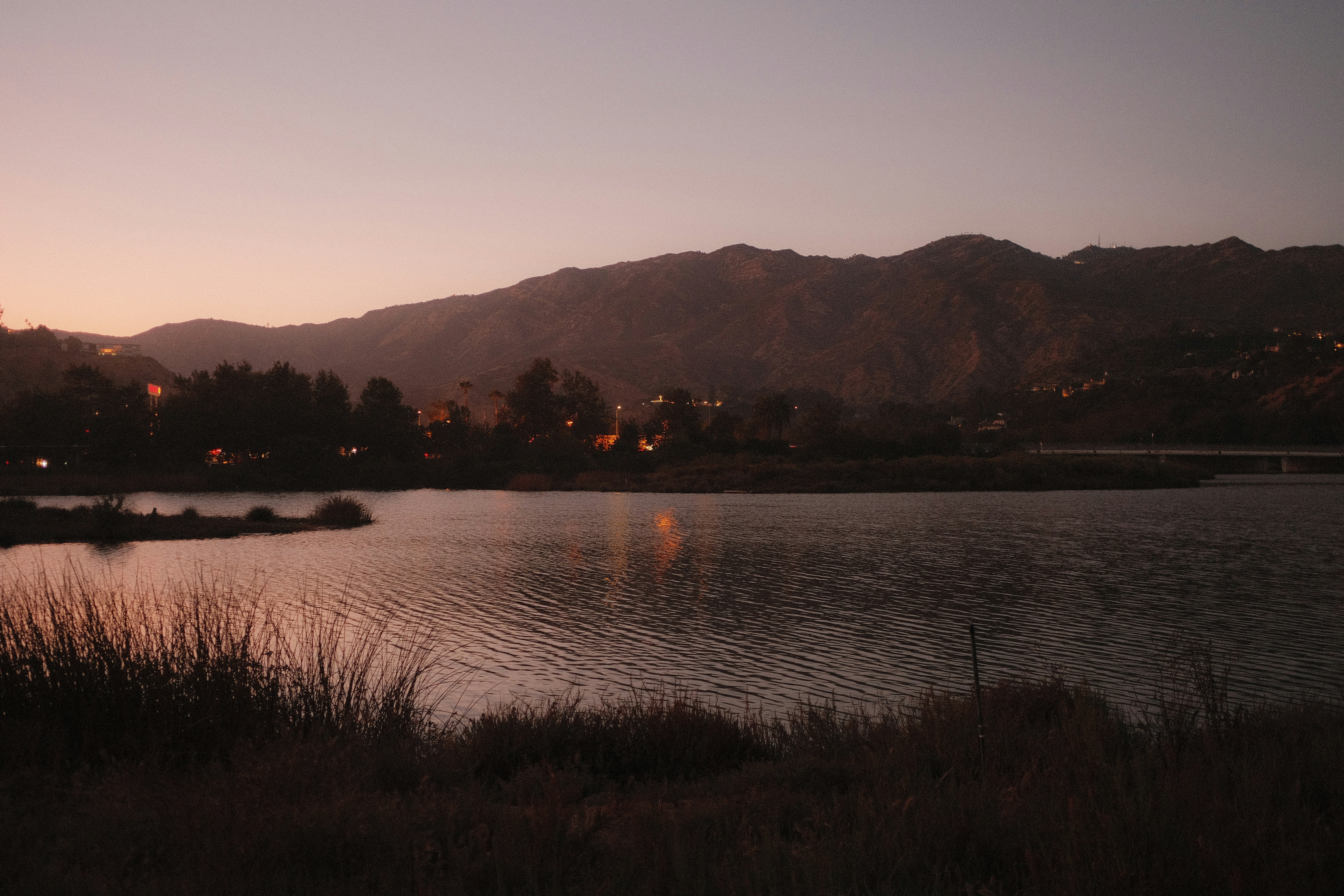 Dusk at the Lake: Quiet Hills and Rippling Water