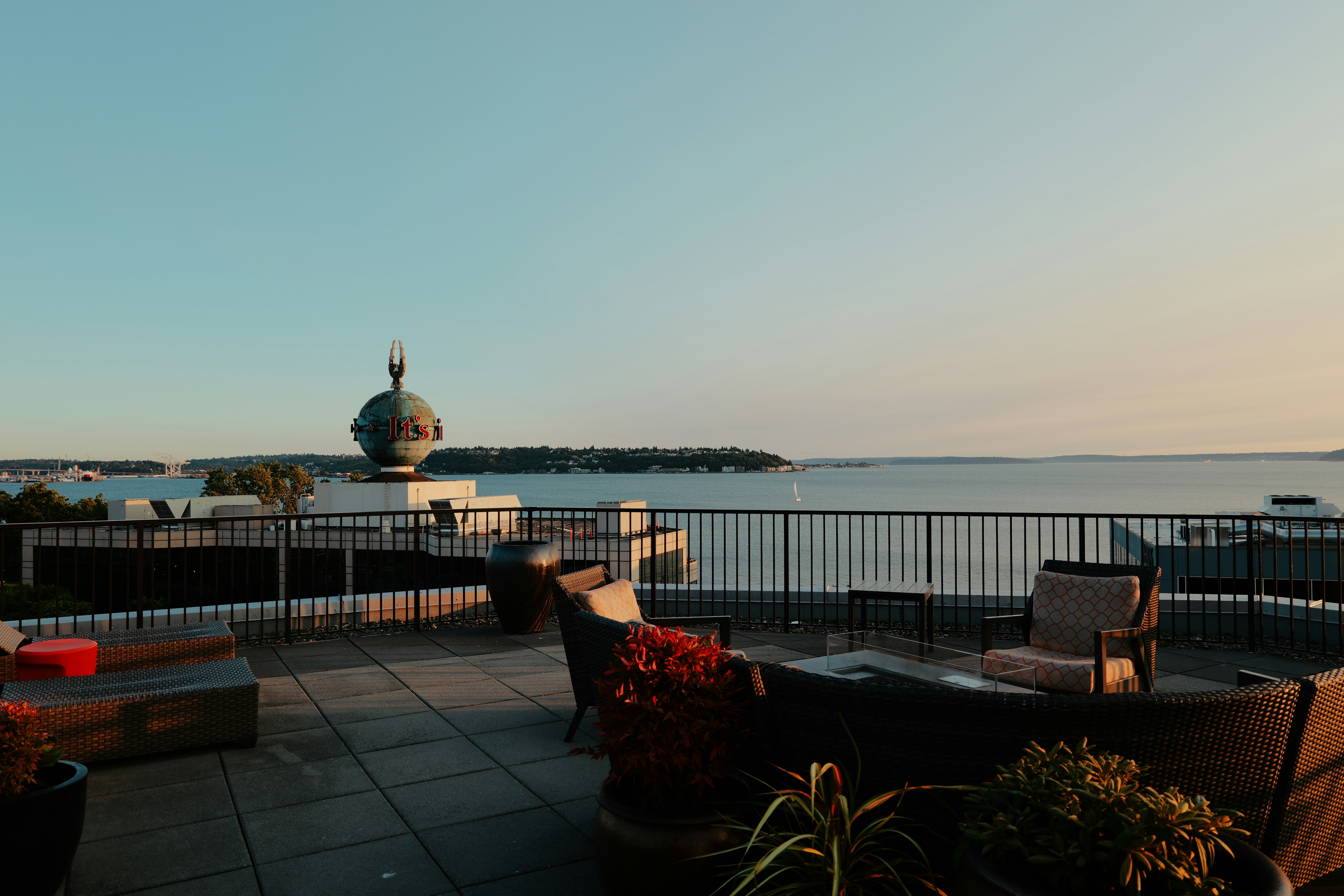 Rooftop Terrace at Dusk Over a Quiet Waterfront