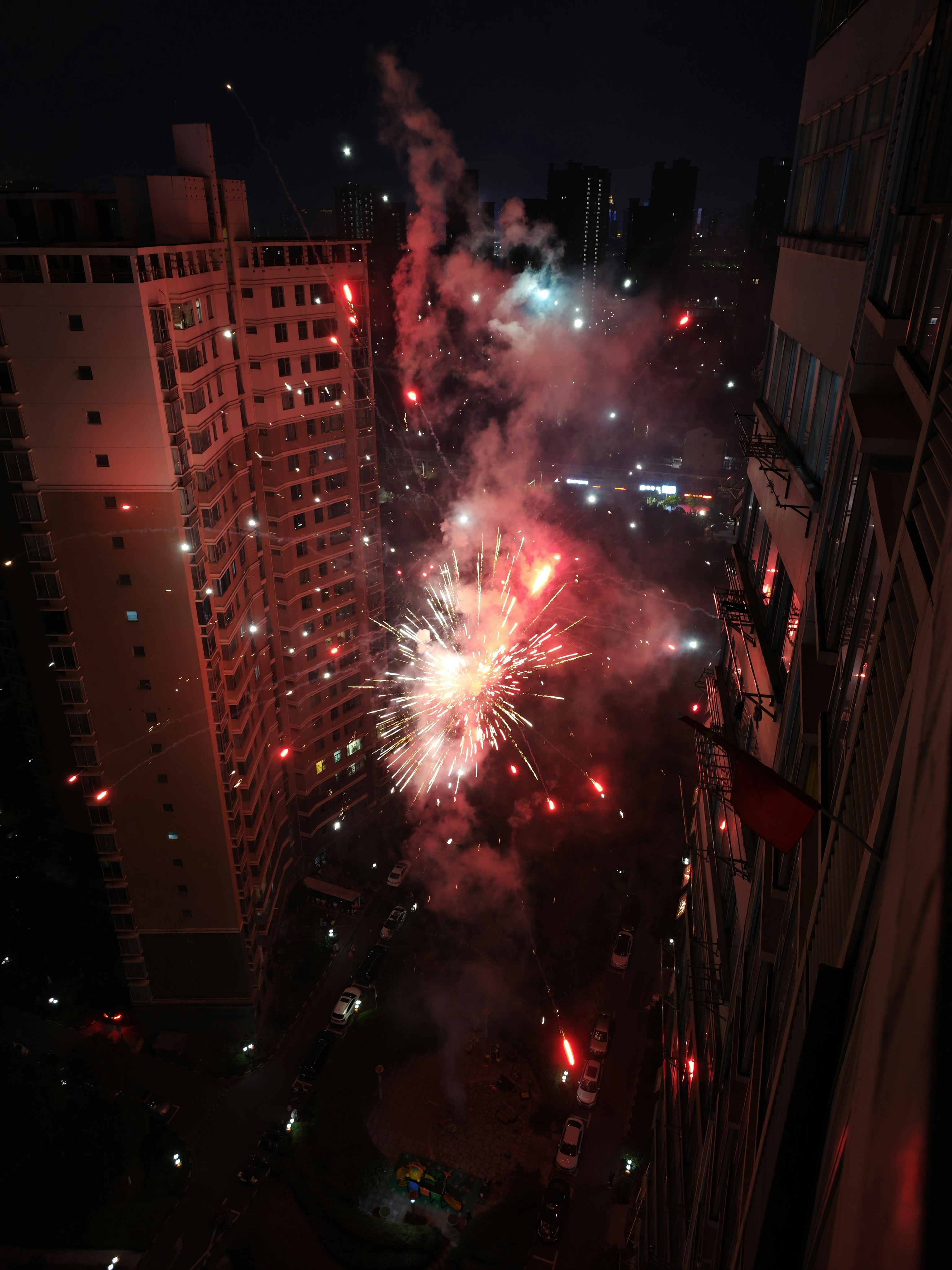 City Night Fireworks Over a Narrow Canyon of Towers