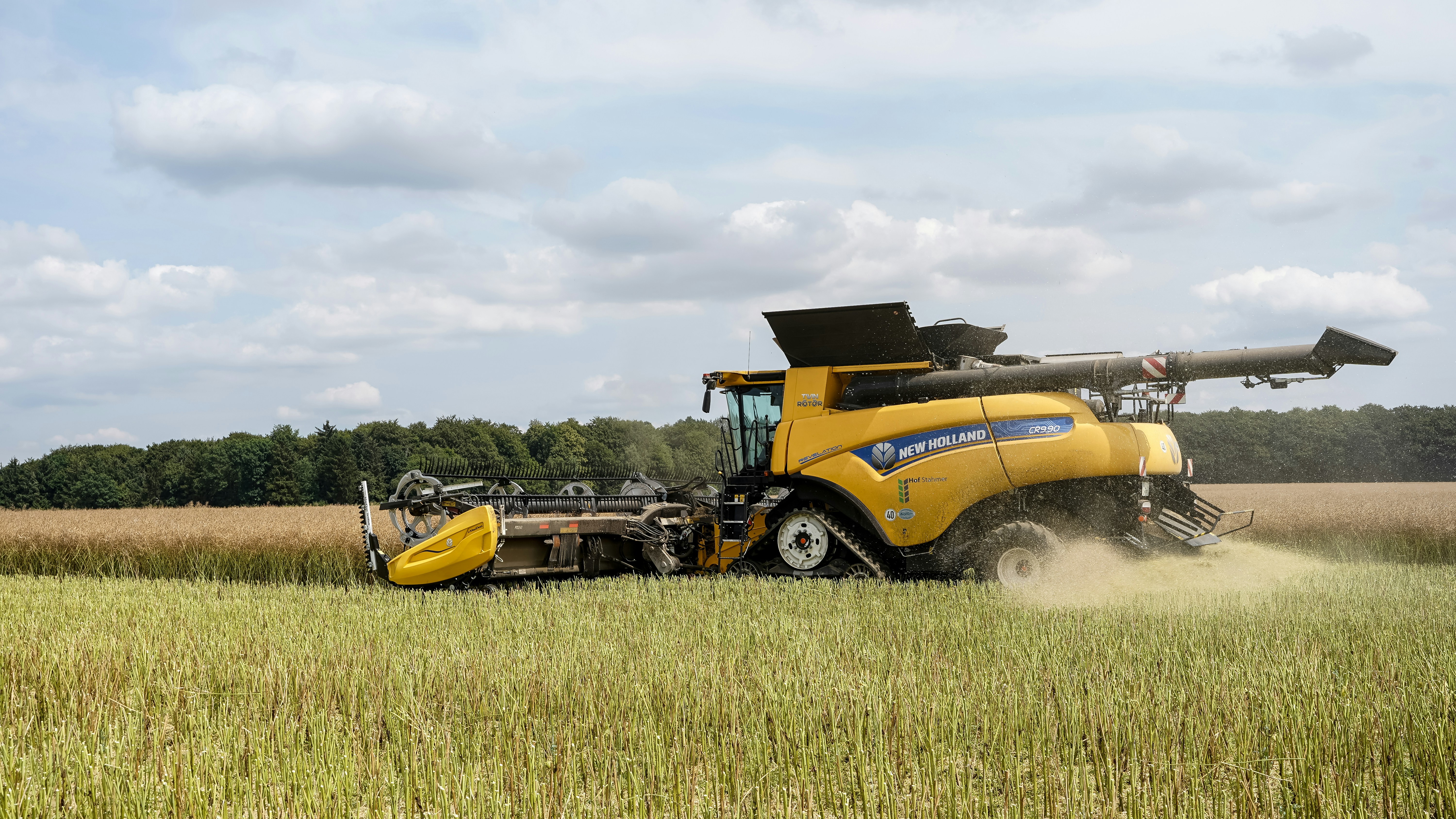 Golden Harvest Machine Prowl Across a Sunlit Field