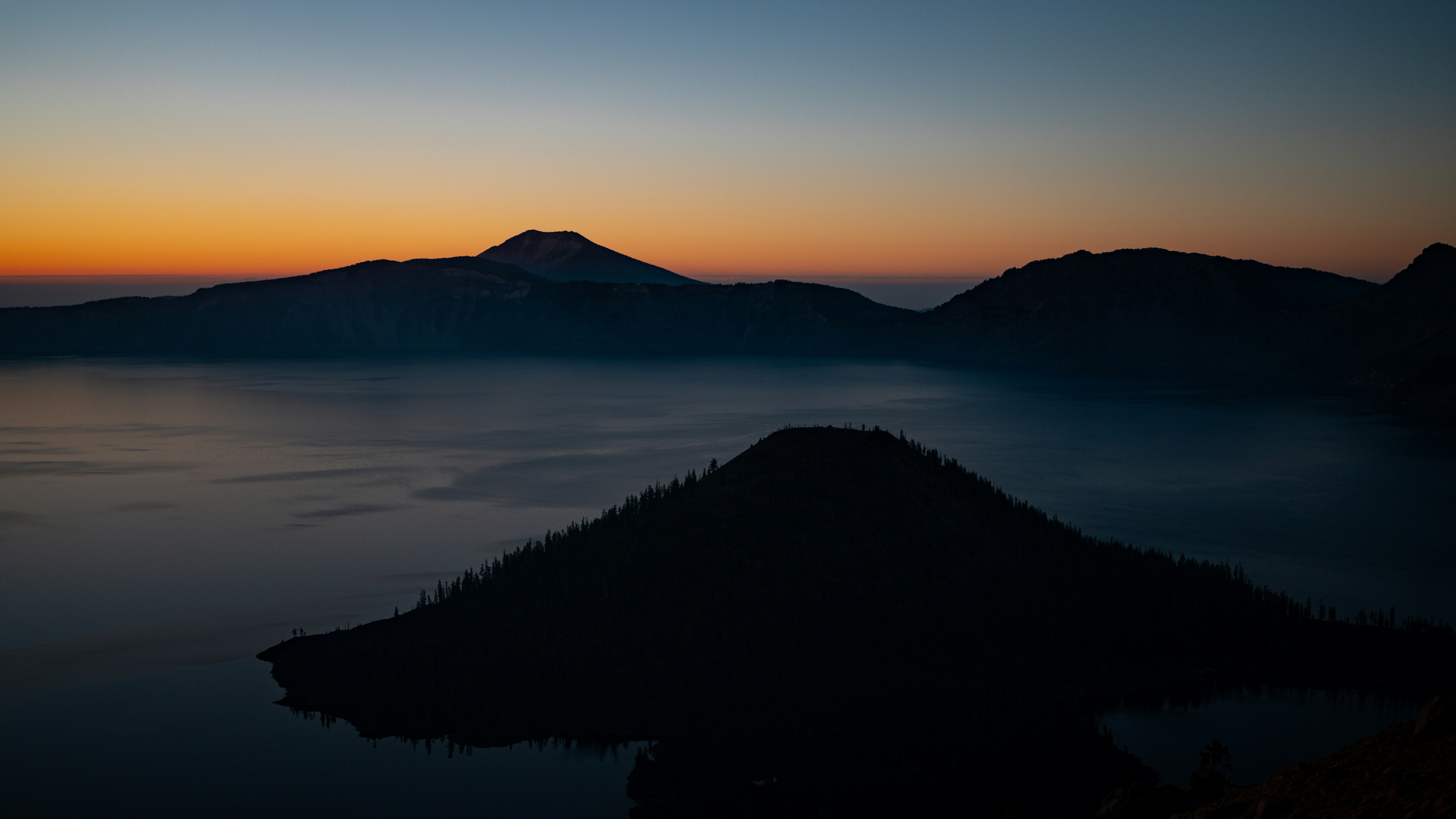 Dawn's Quiet Island: silhouettes against a awakening horizon