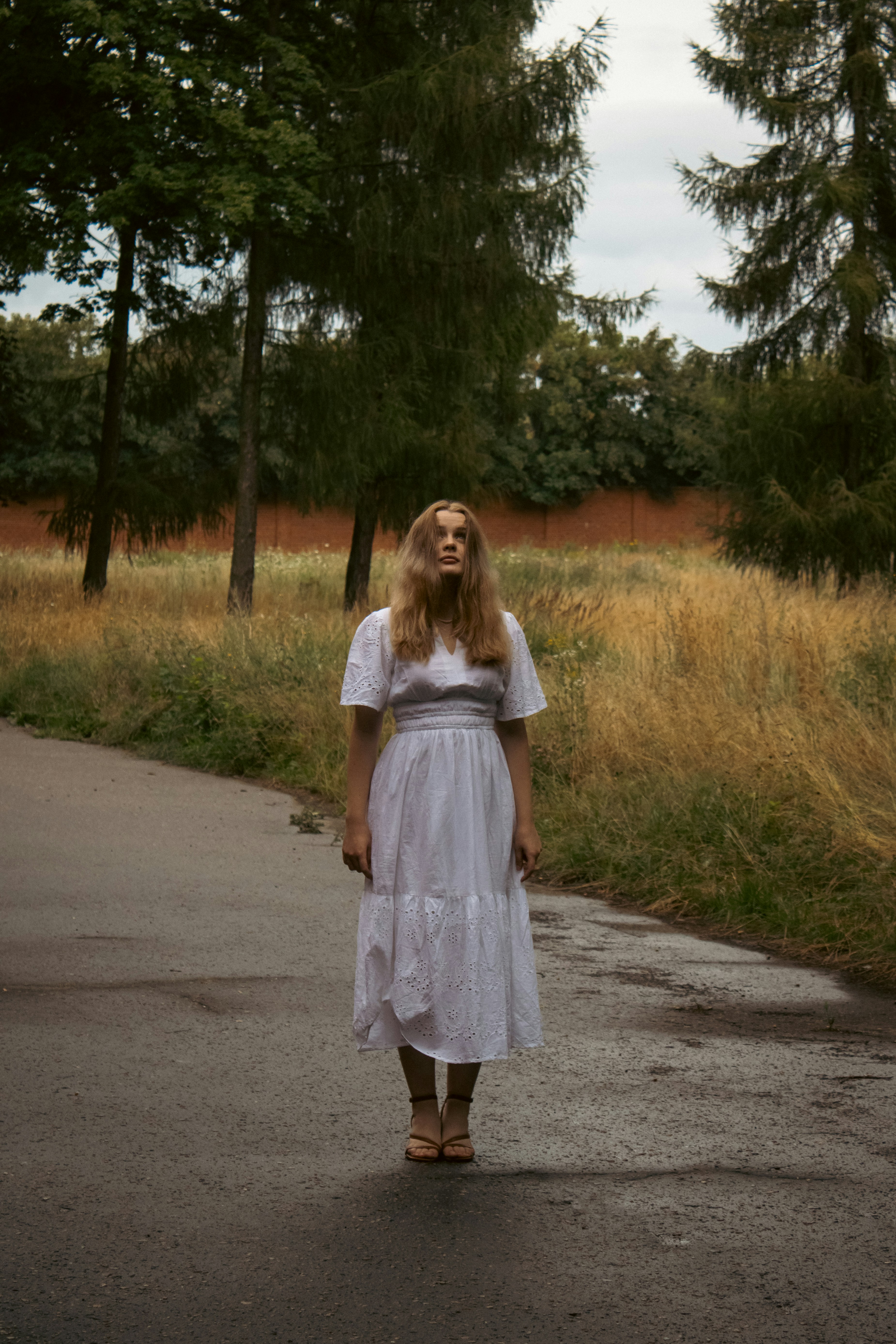 Sheer White Dress on a Quiet Road Through Golden Field