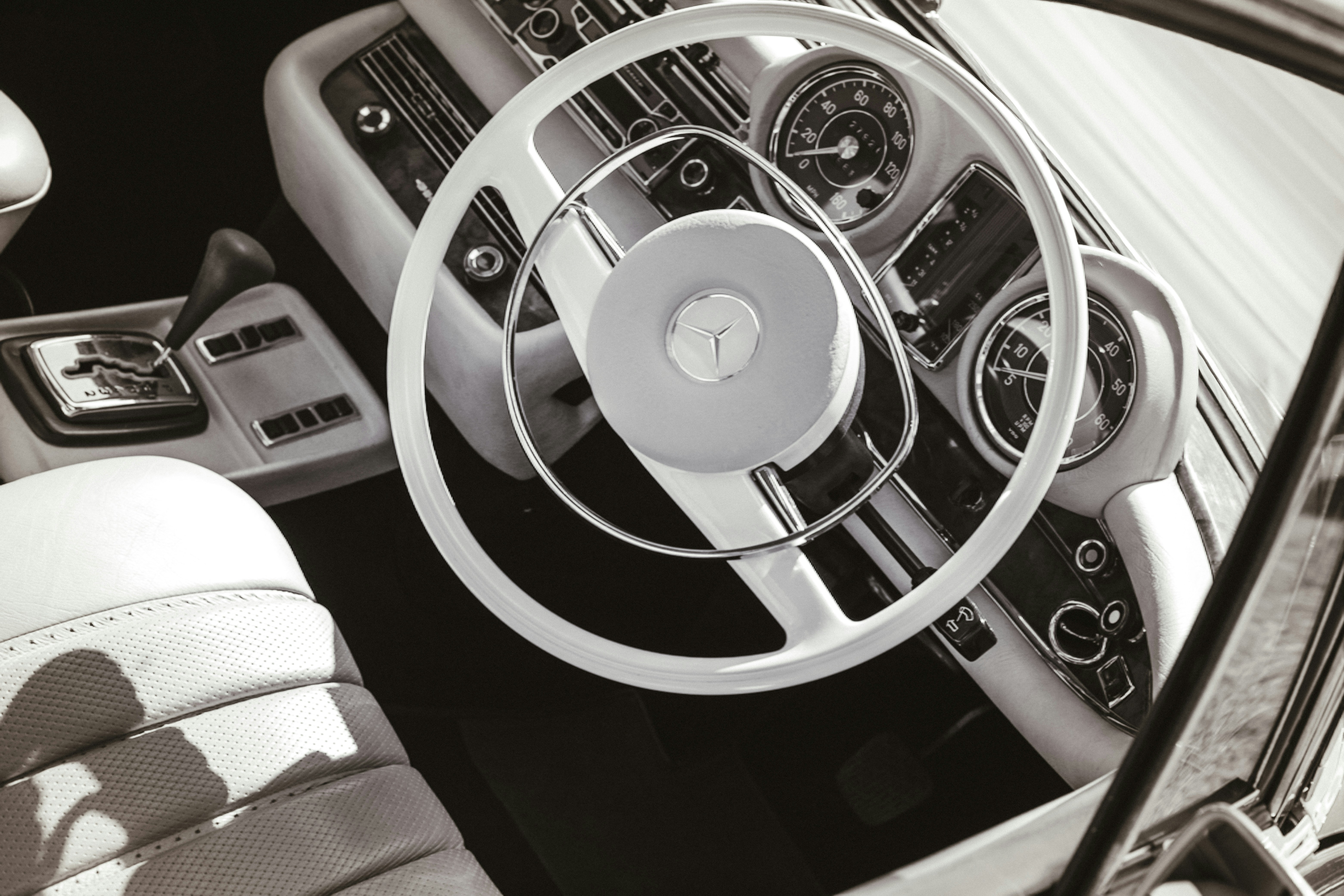 Timeless steering: a vintage Mercedes cockpit bathed in amber glow.