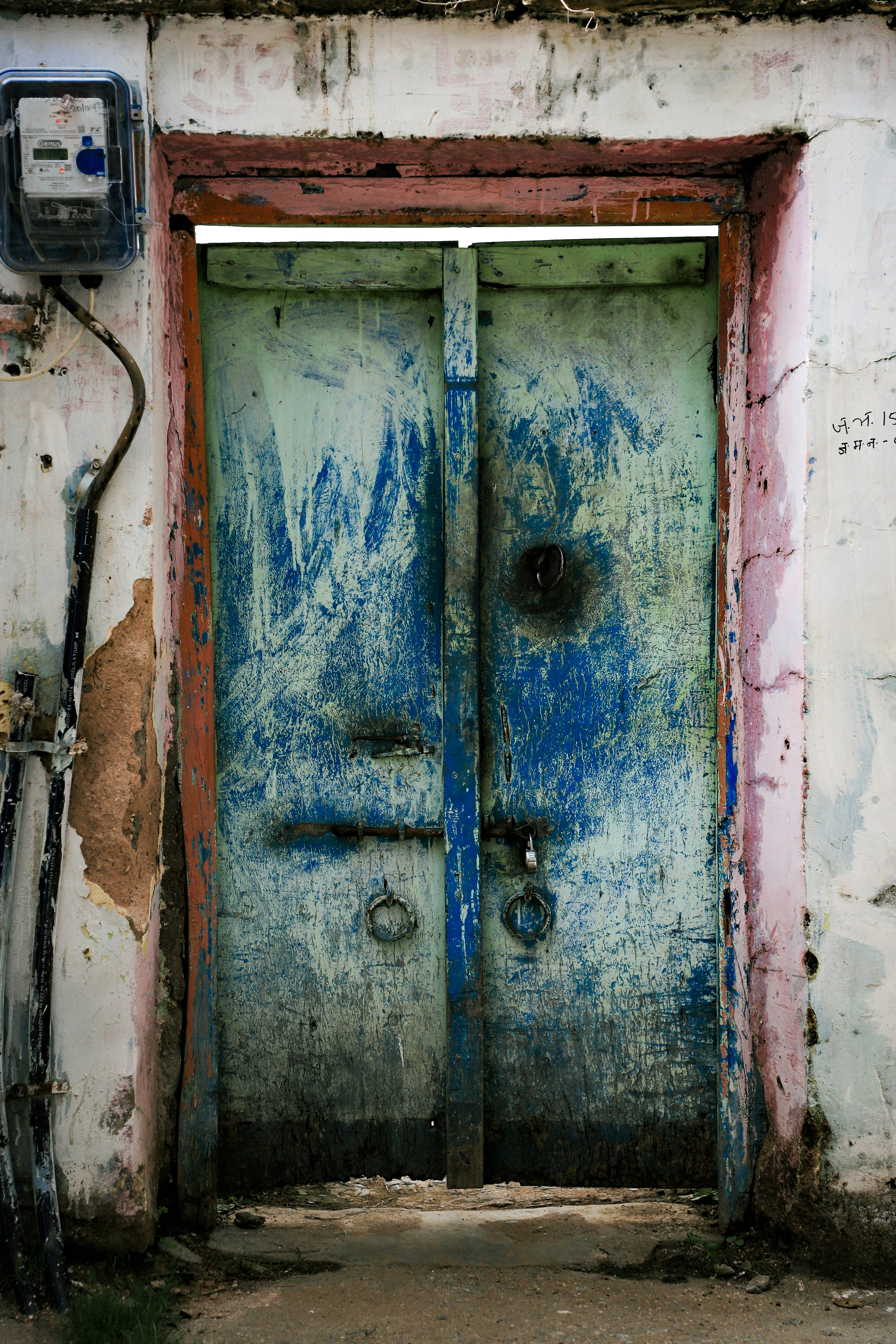 Weathered Doorway: A Blues and Pink Frame in Time-worn Walls