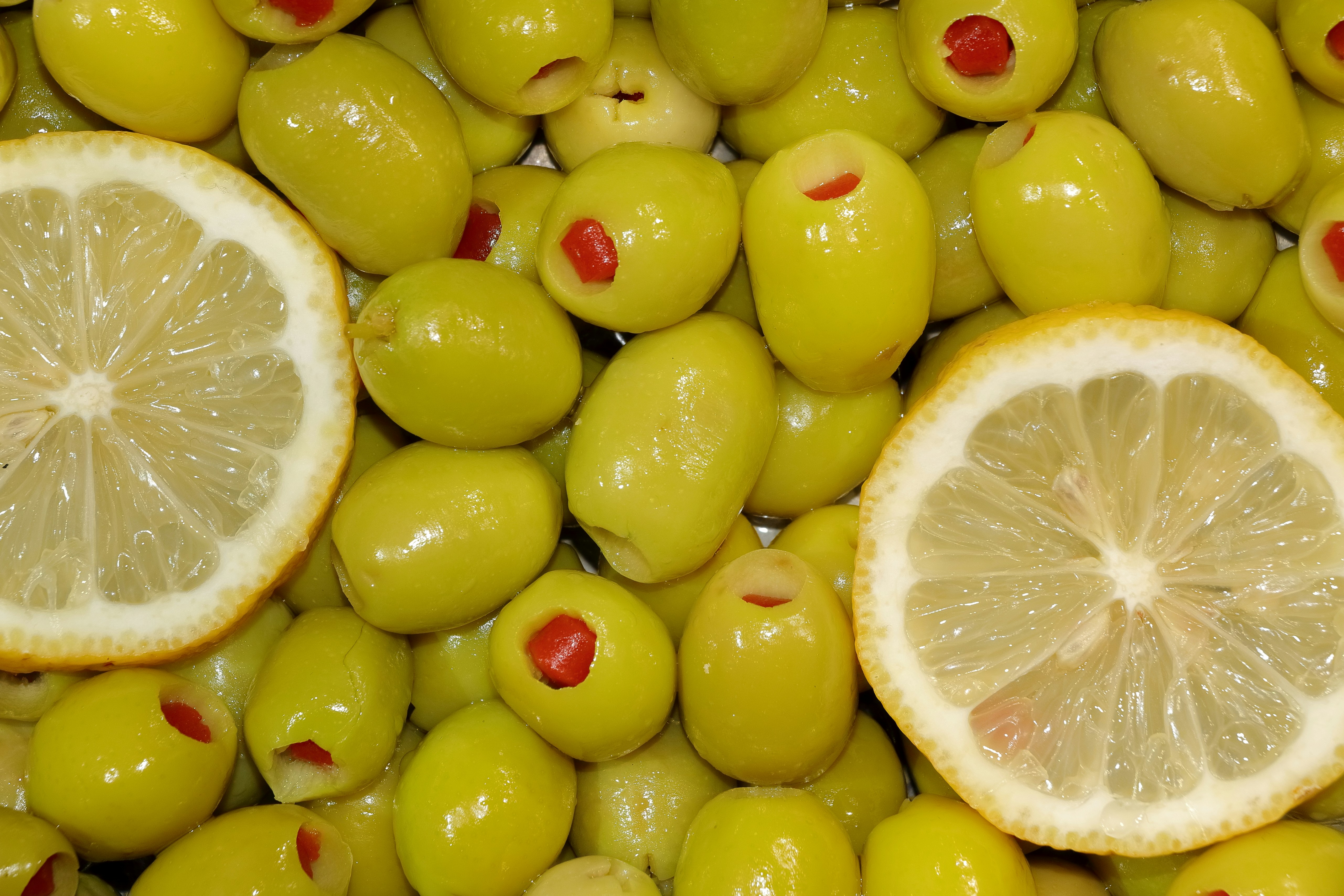 Lemon Slices Framed by a Sea of Green Olives