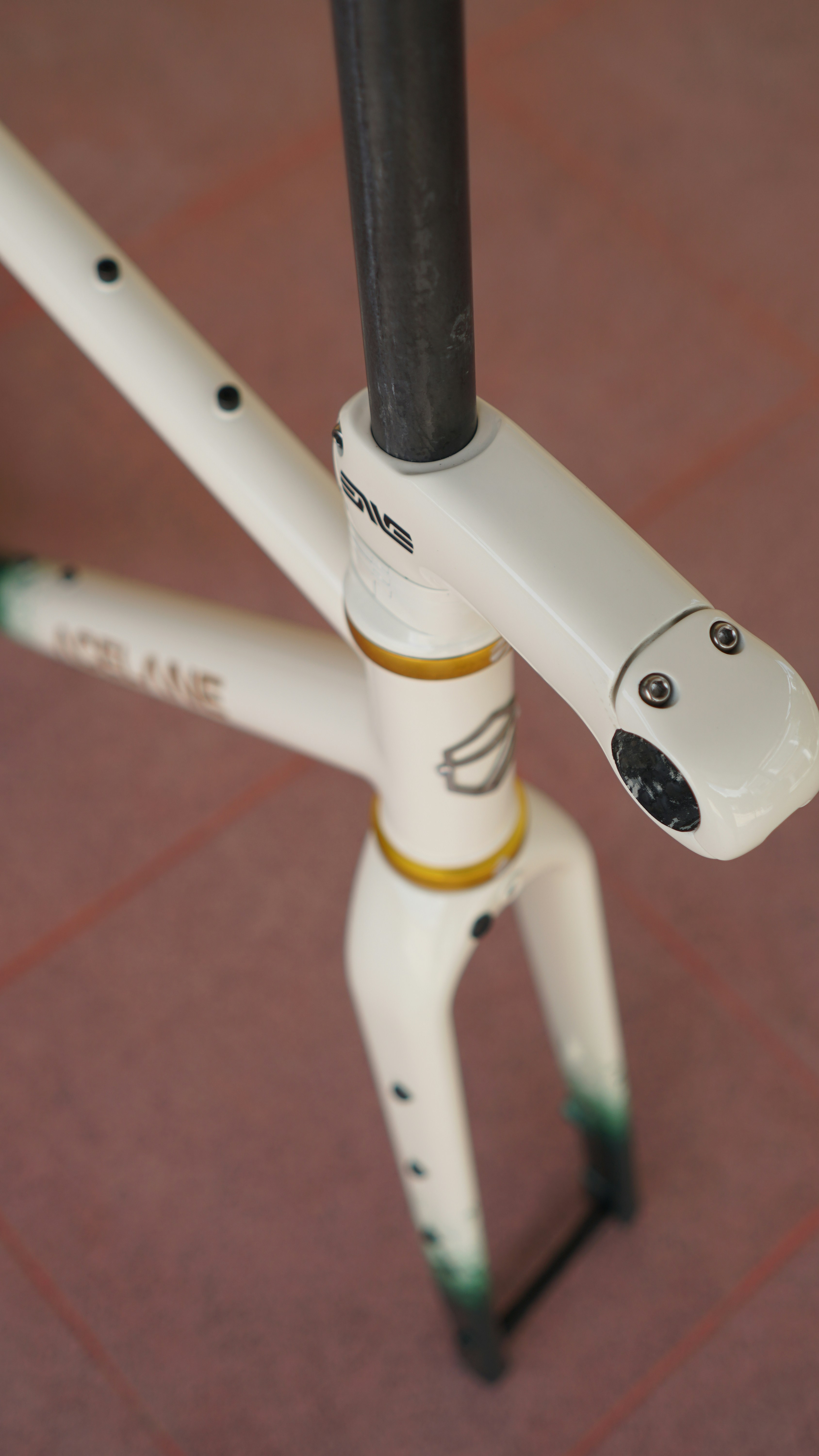 Frame of a Painted Ride: Close-up of a White Bicycle Frame with Gold Accents
