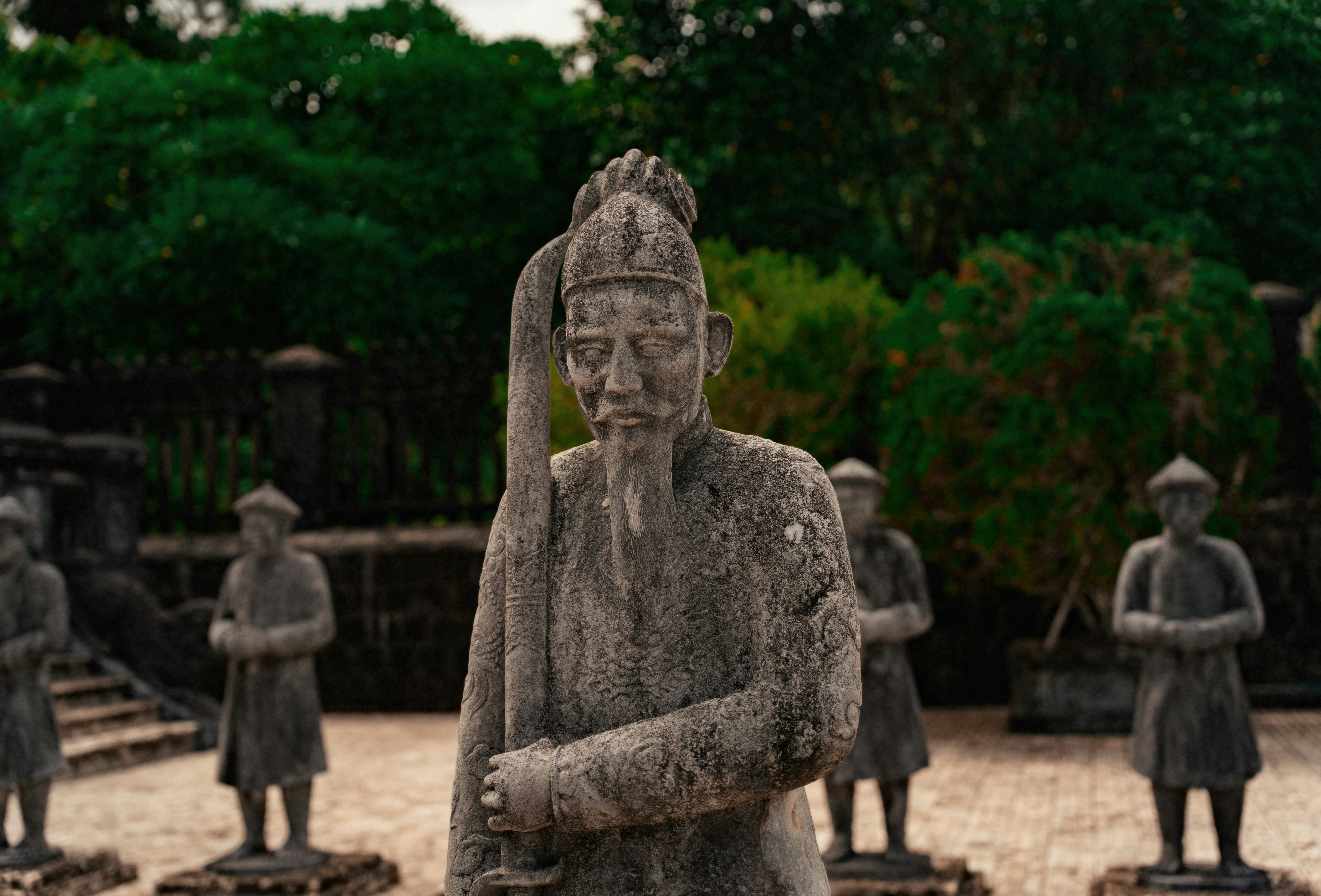 Stone Guardian with Staff in a Quiet Courtyard