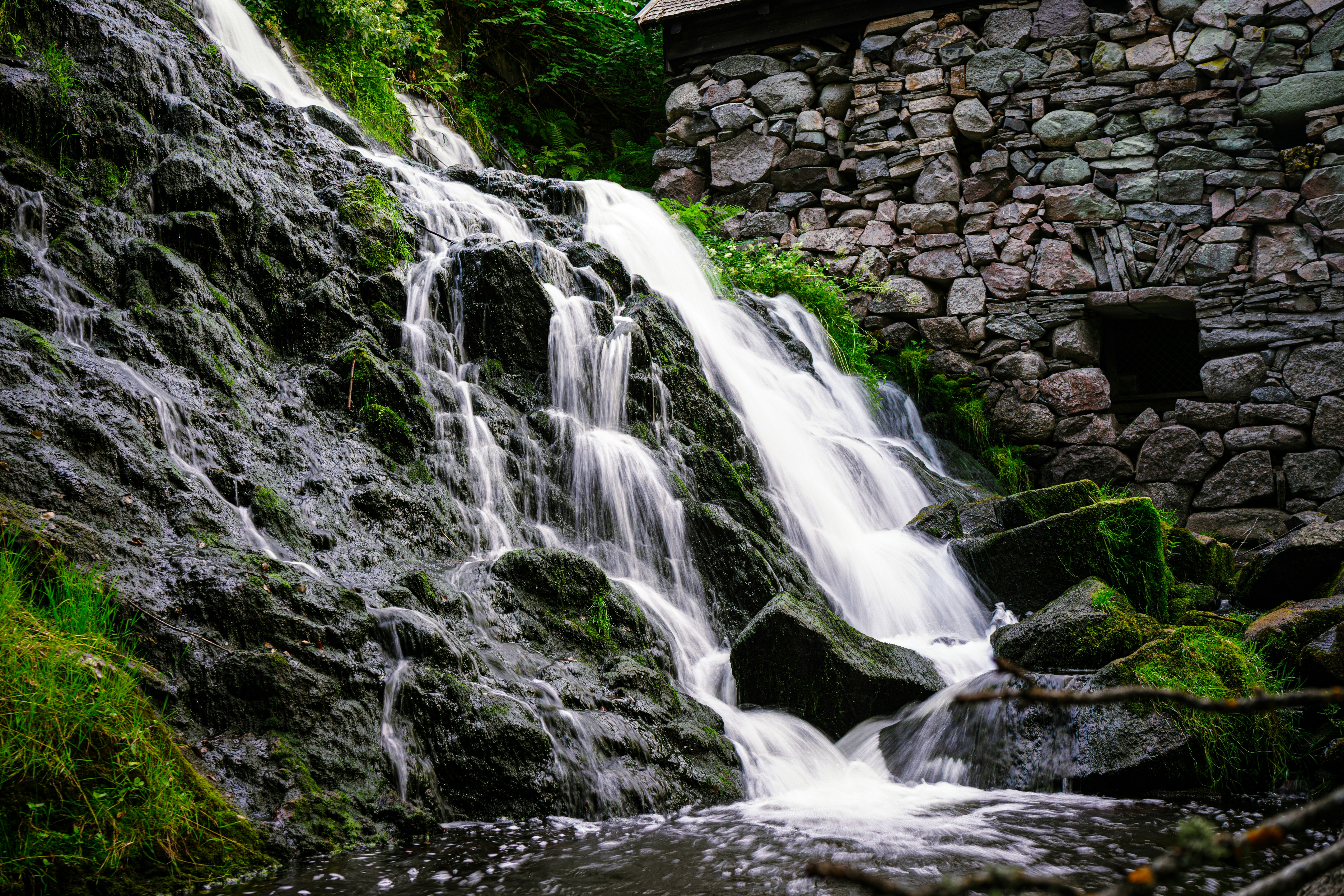 Mossy Cascade Beneath a Stone Facade