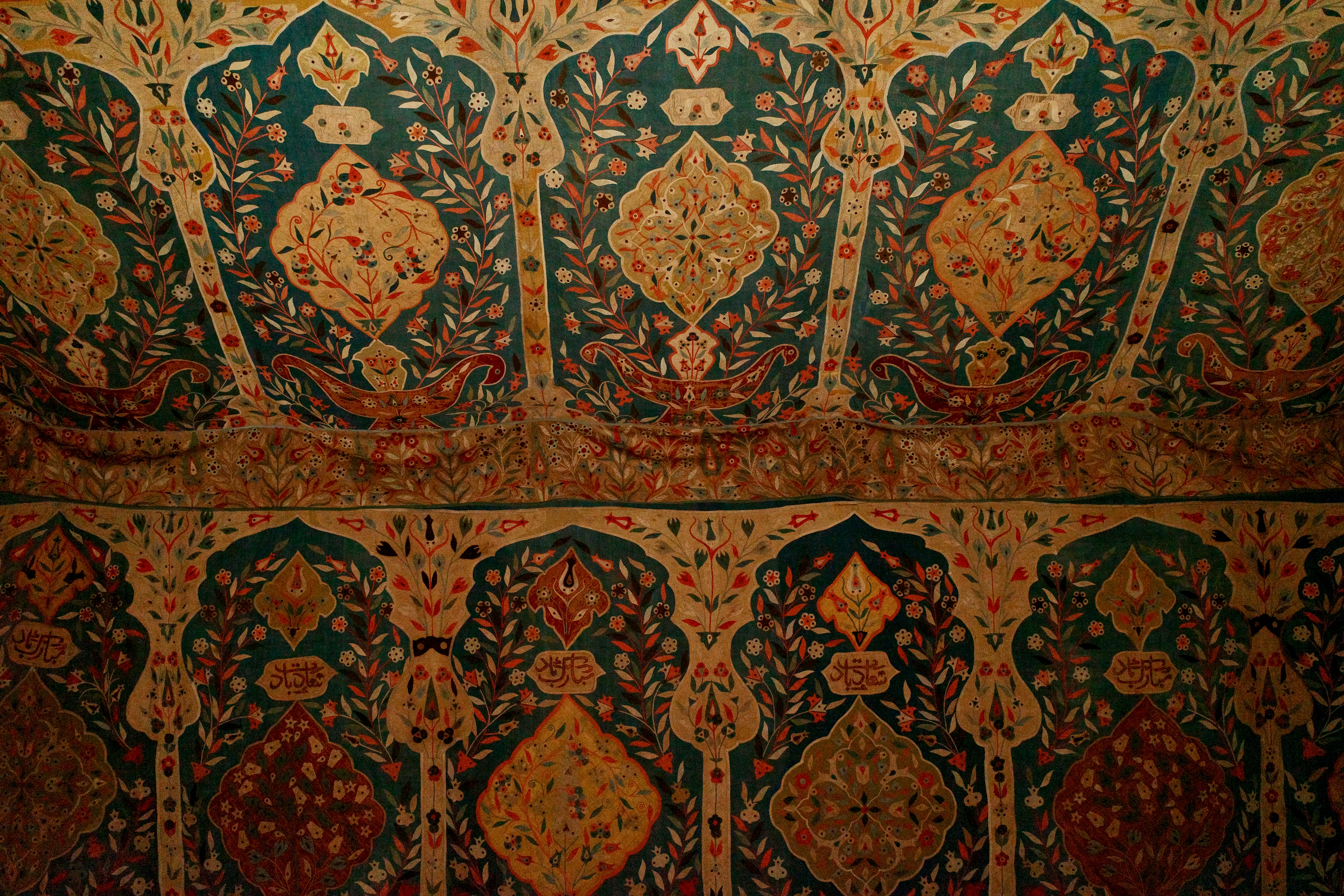 Ornate Textile Mosaic: Repeating Medallions in Dim Light