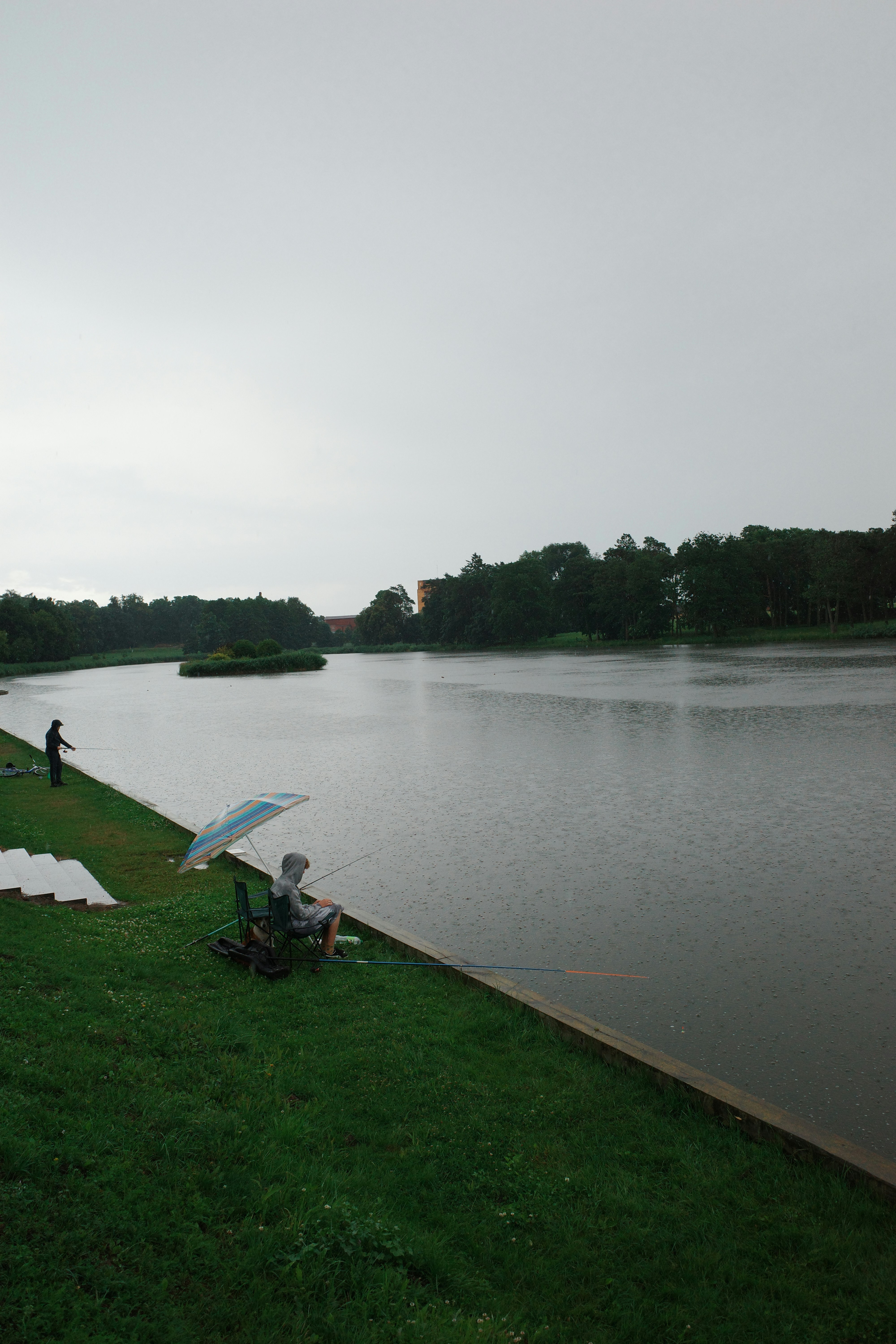 Lakeside Anglers at Dusk: A Quiet Moment by the Pier