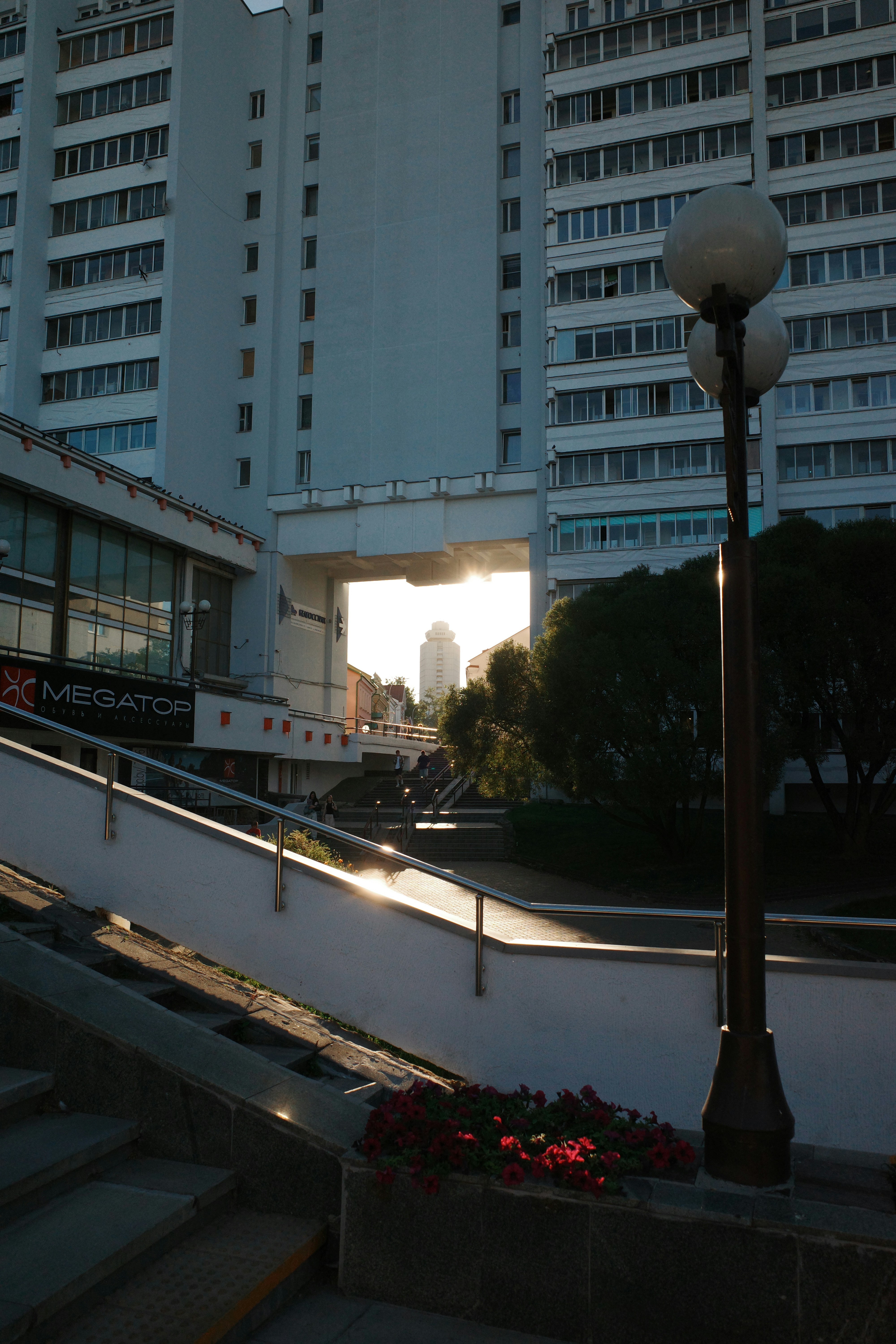 Sunlit Archway Between Towers: A Corridor to Distant Light