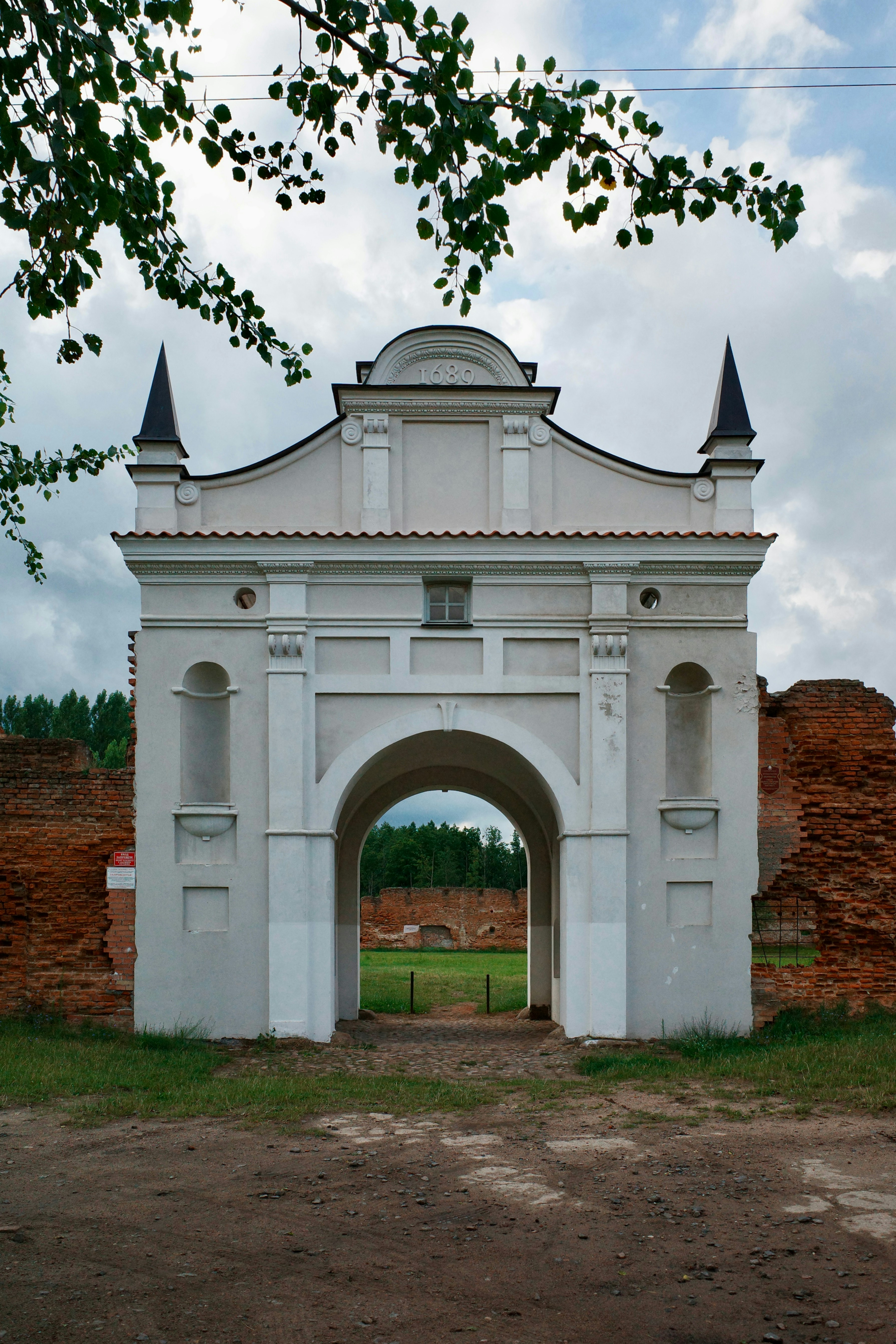 White Archway Amid Red Brick Ruins