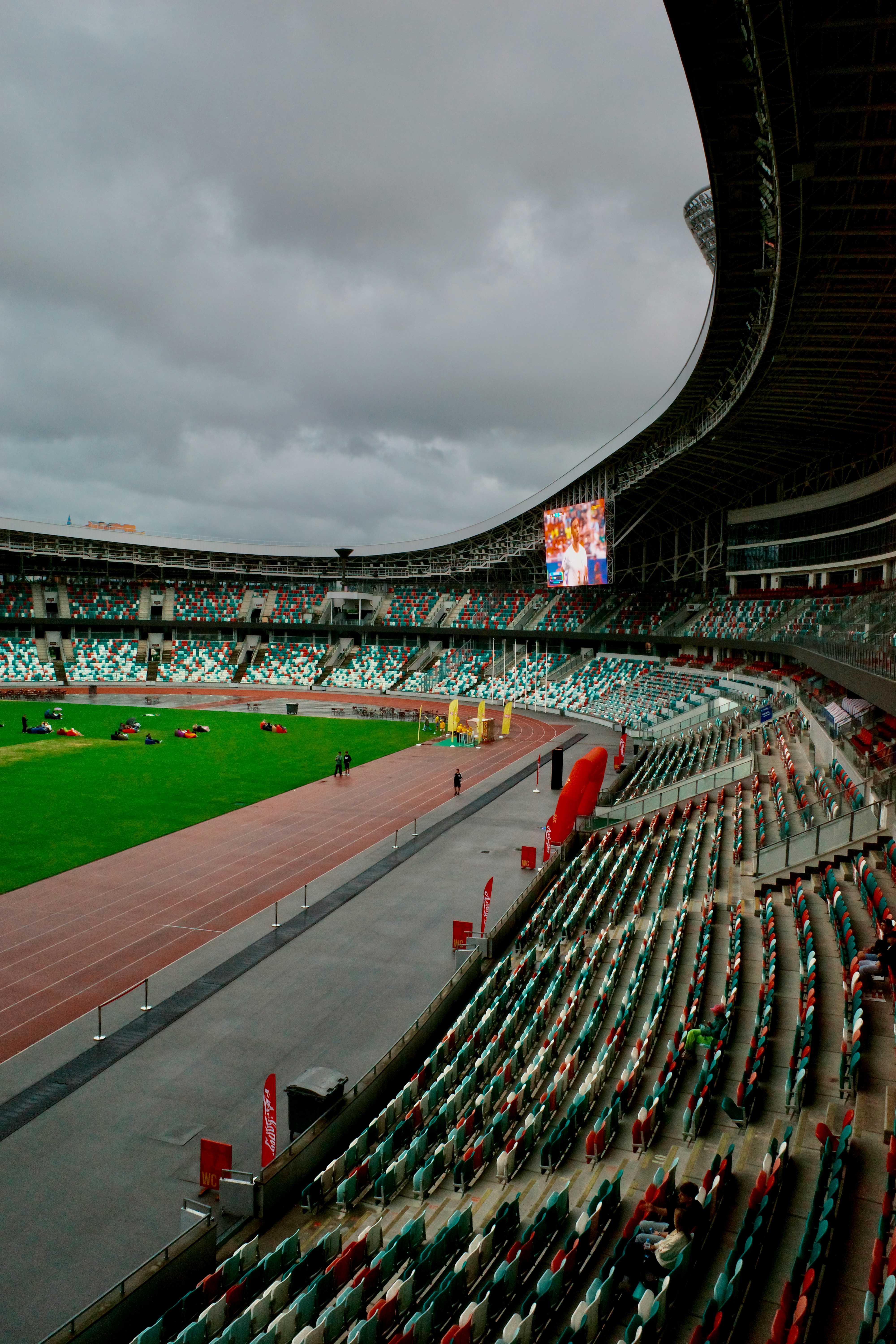 A Quiet Moment in the Arena: Curved Stand and Field Under Overcast Sky