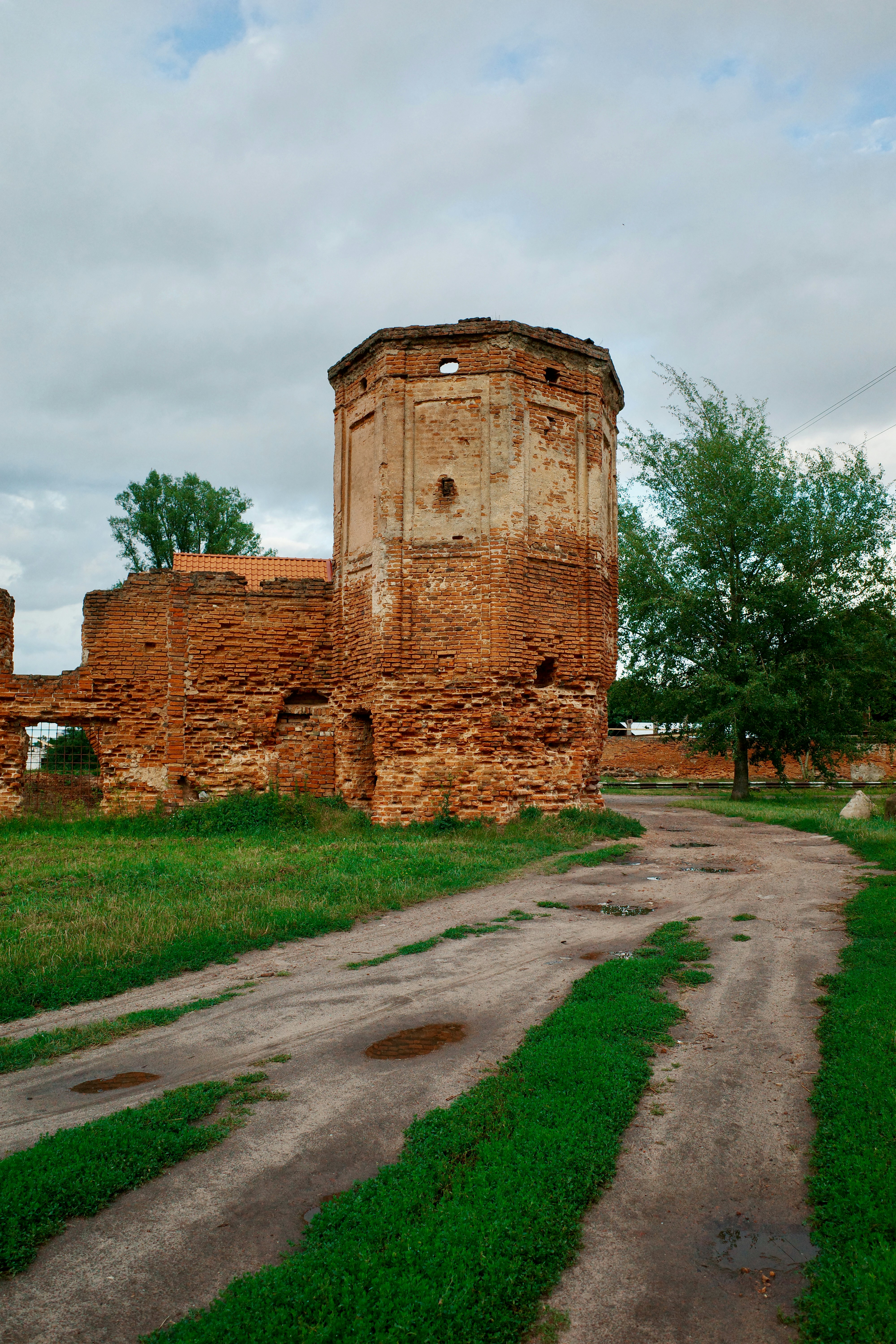 Brick Niche: A Towered Ruin Beside a Winding Road