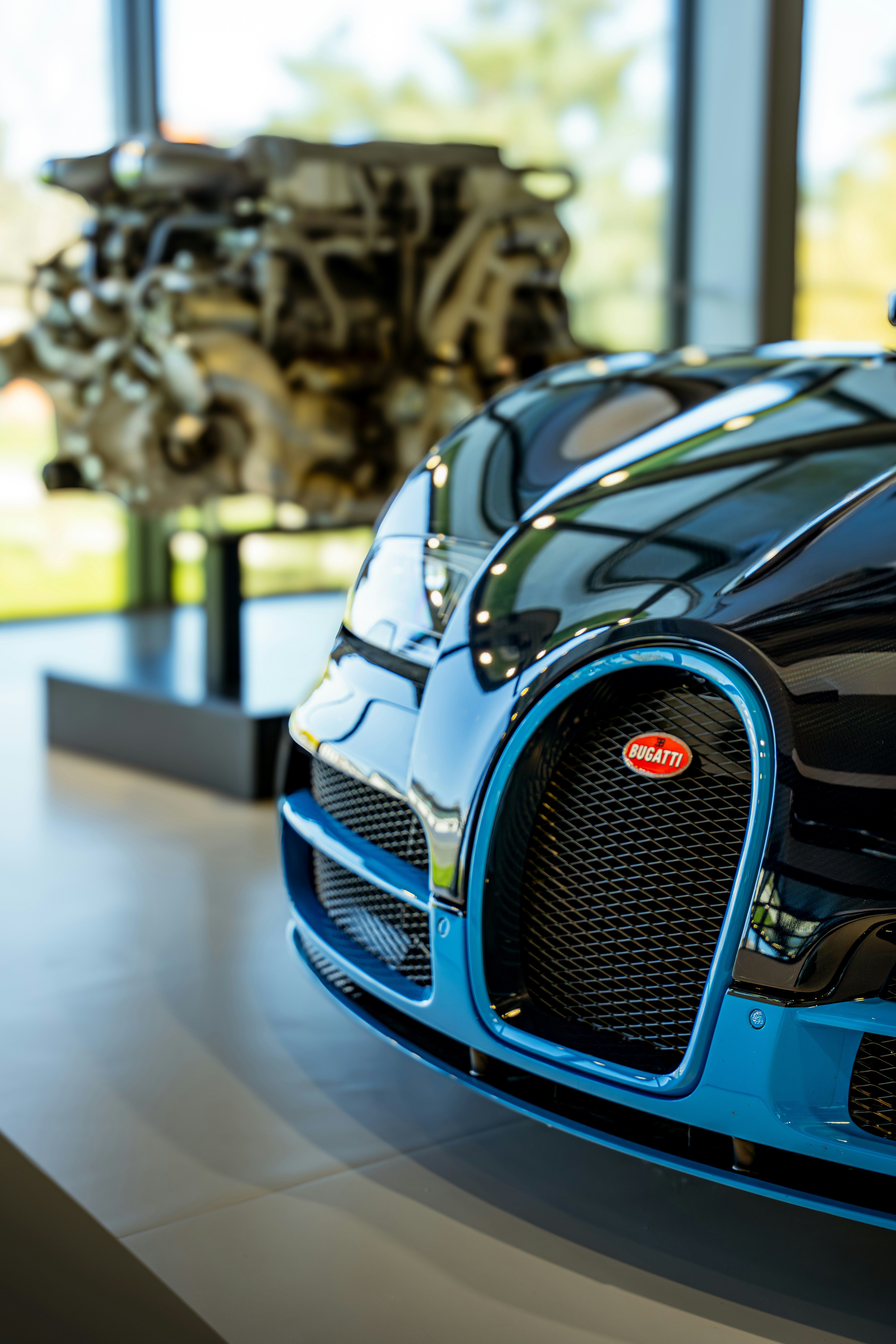 Blue Bugatti Grille: A Close-Up of Automotive Icon in a Modern Showroom