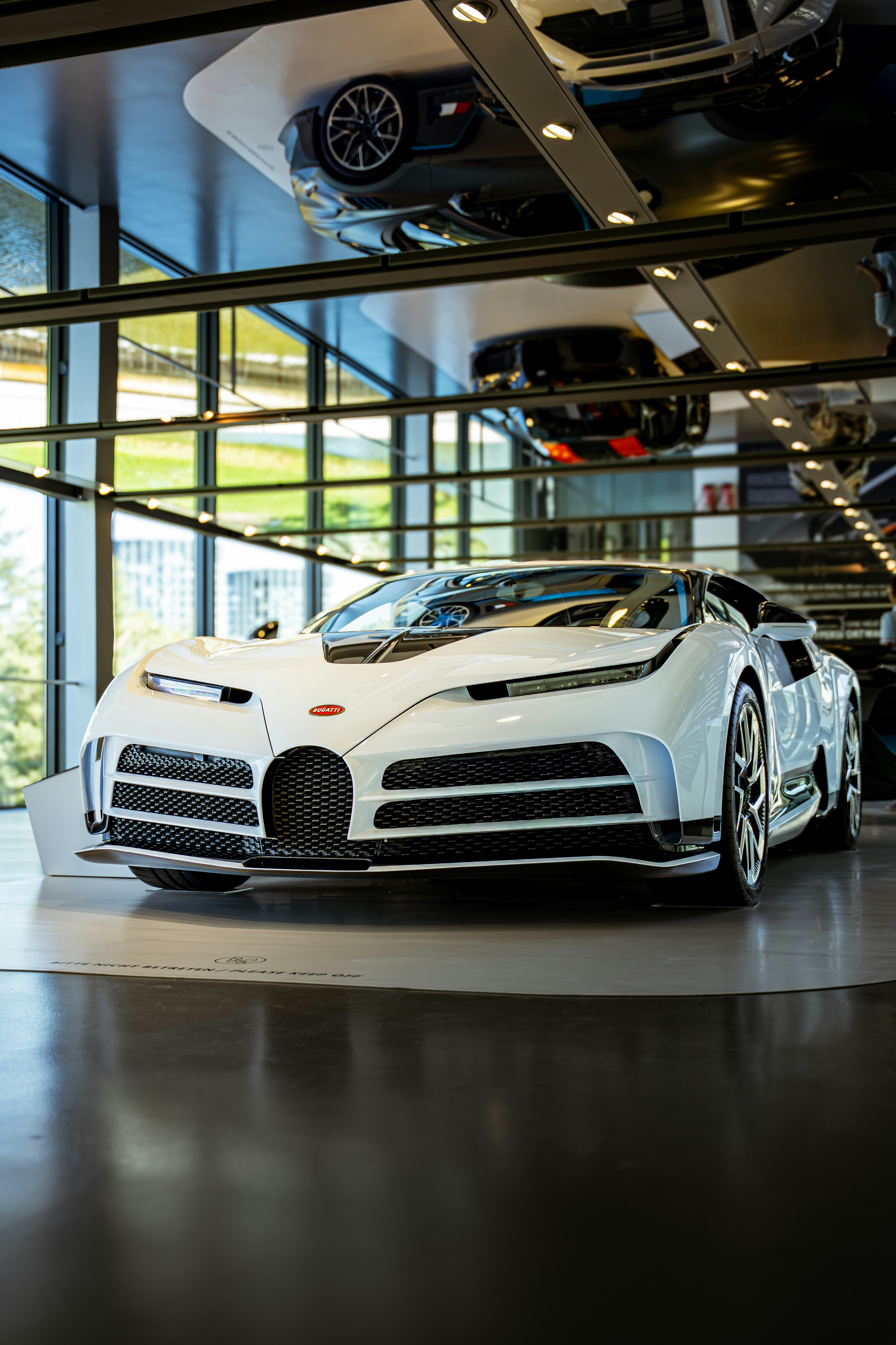 White Bugatti Roar: A showroom stance under mirrored ceilings