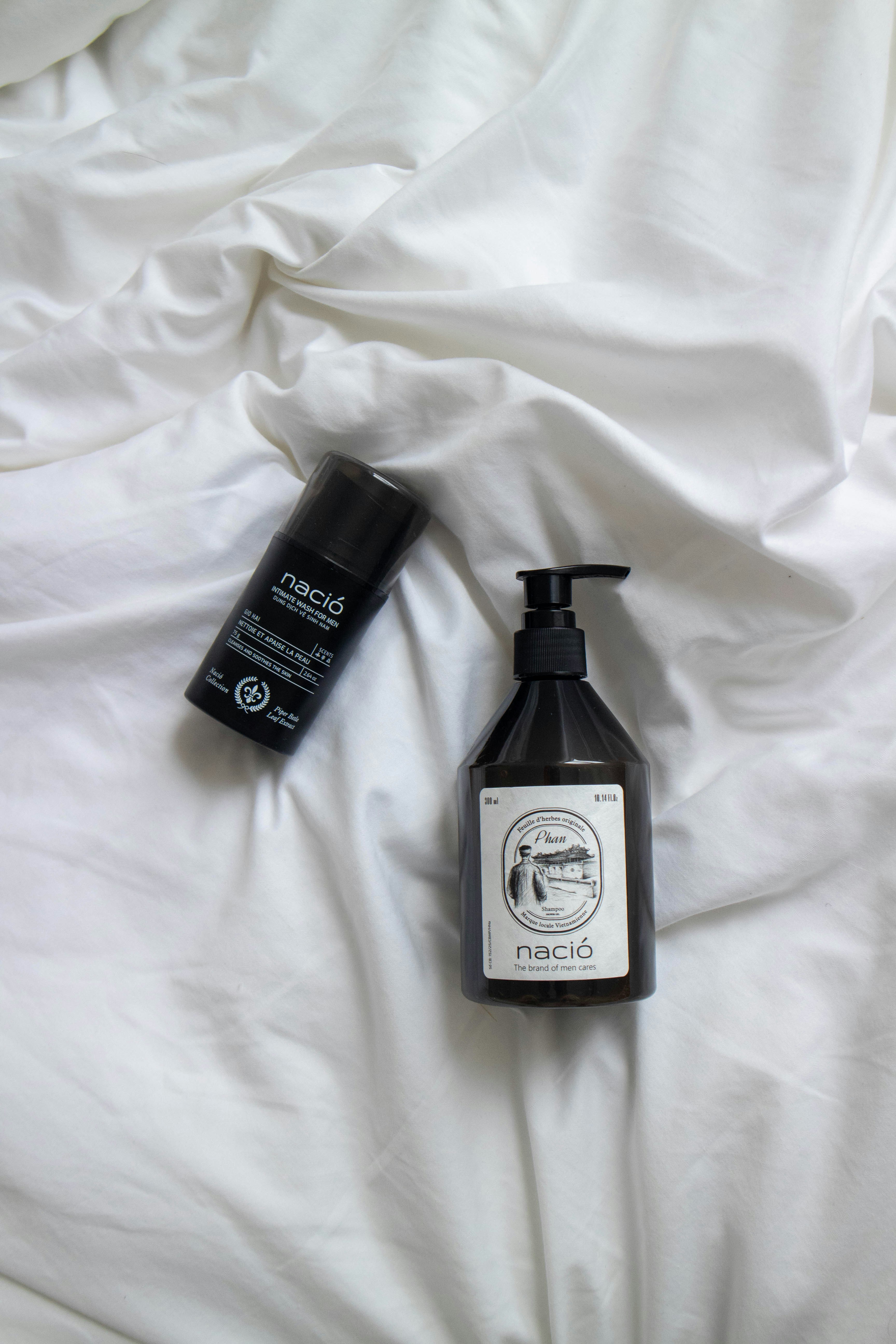 Minimalist Grooming: Two Bottles Rest on Crisp White Linen