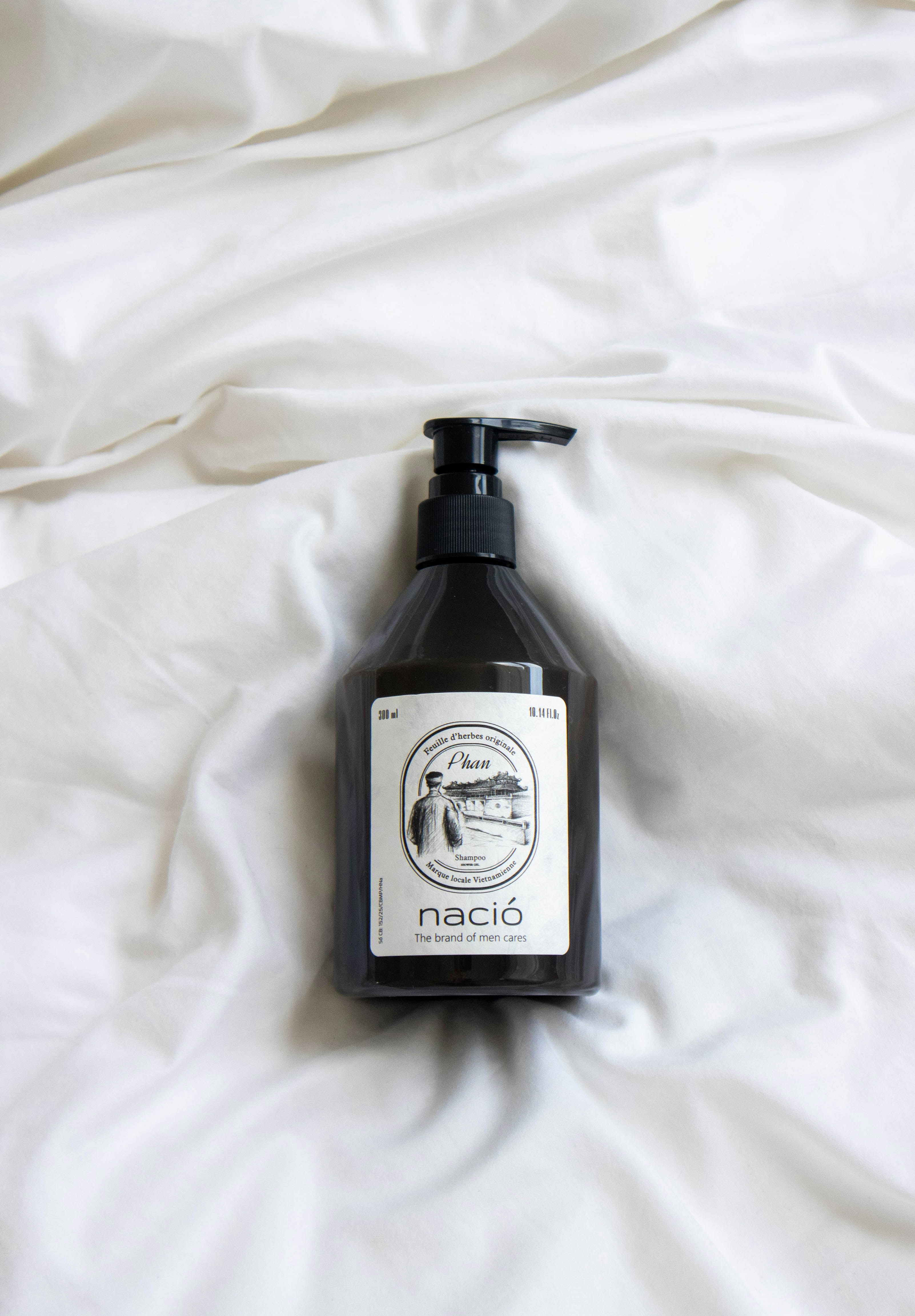 Minimalist Lotion Bottle on Soft White Linen