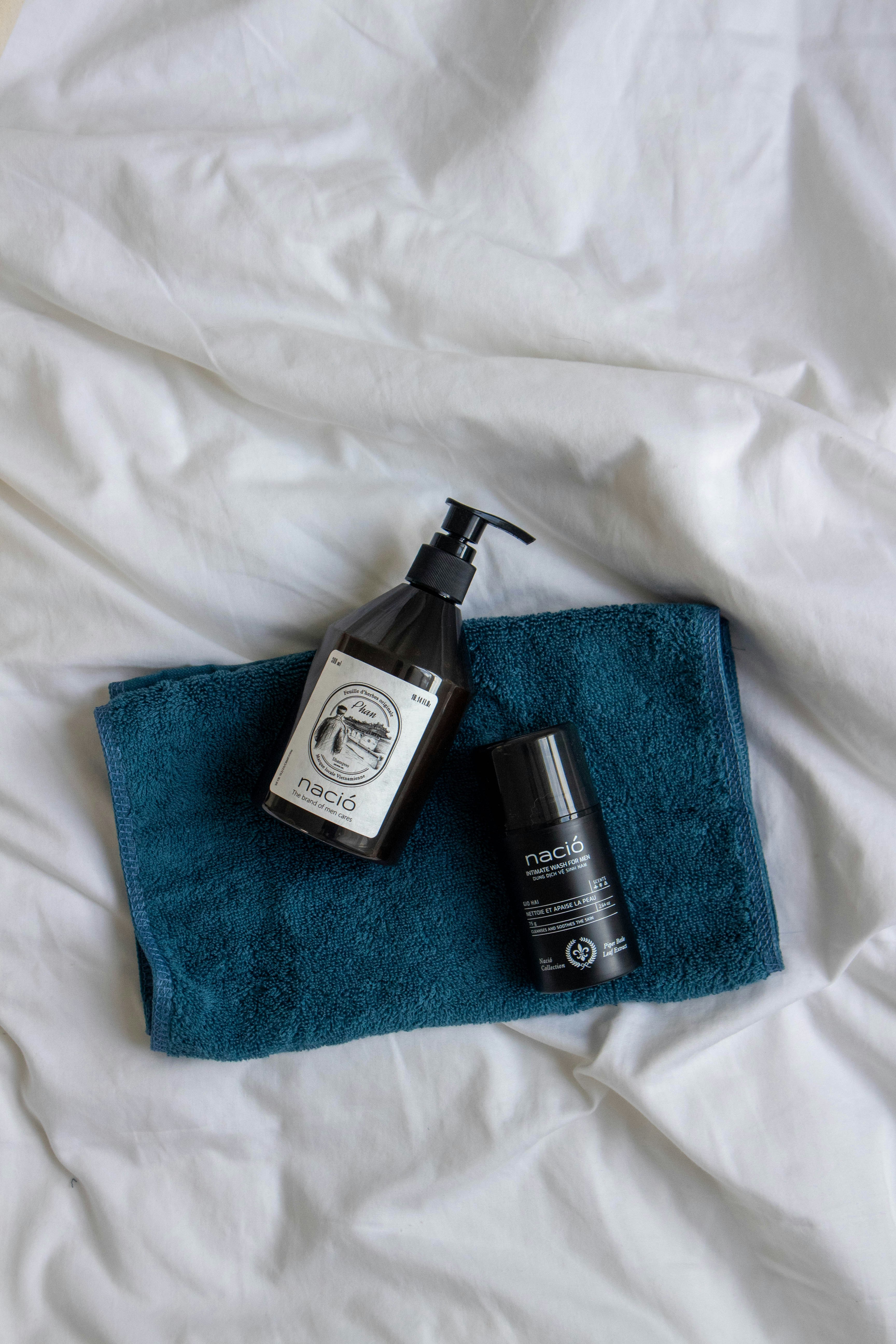 Spa Essentials on a Teal Towel: Clean Lines and Calm Countertop