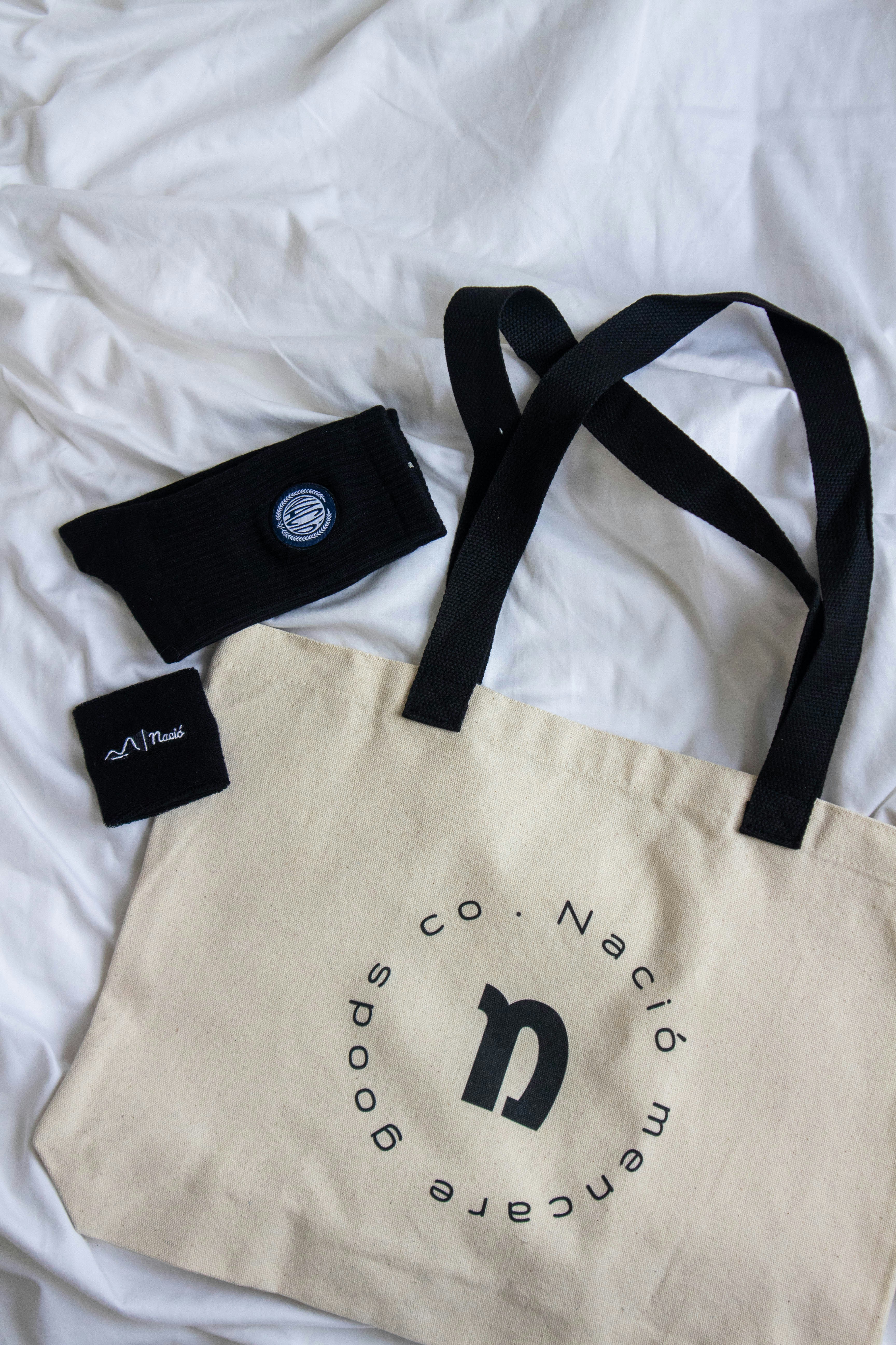 Minimalist Canvas Tote with Circular Logo on a Quiet Bedscape