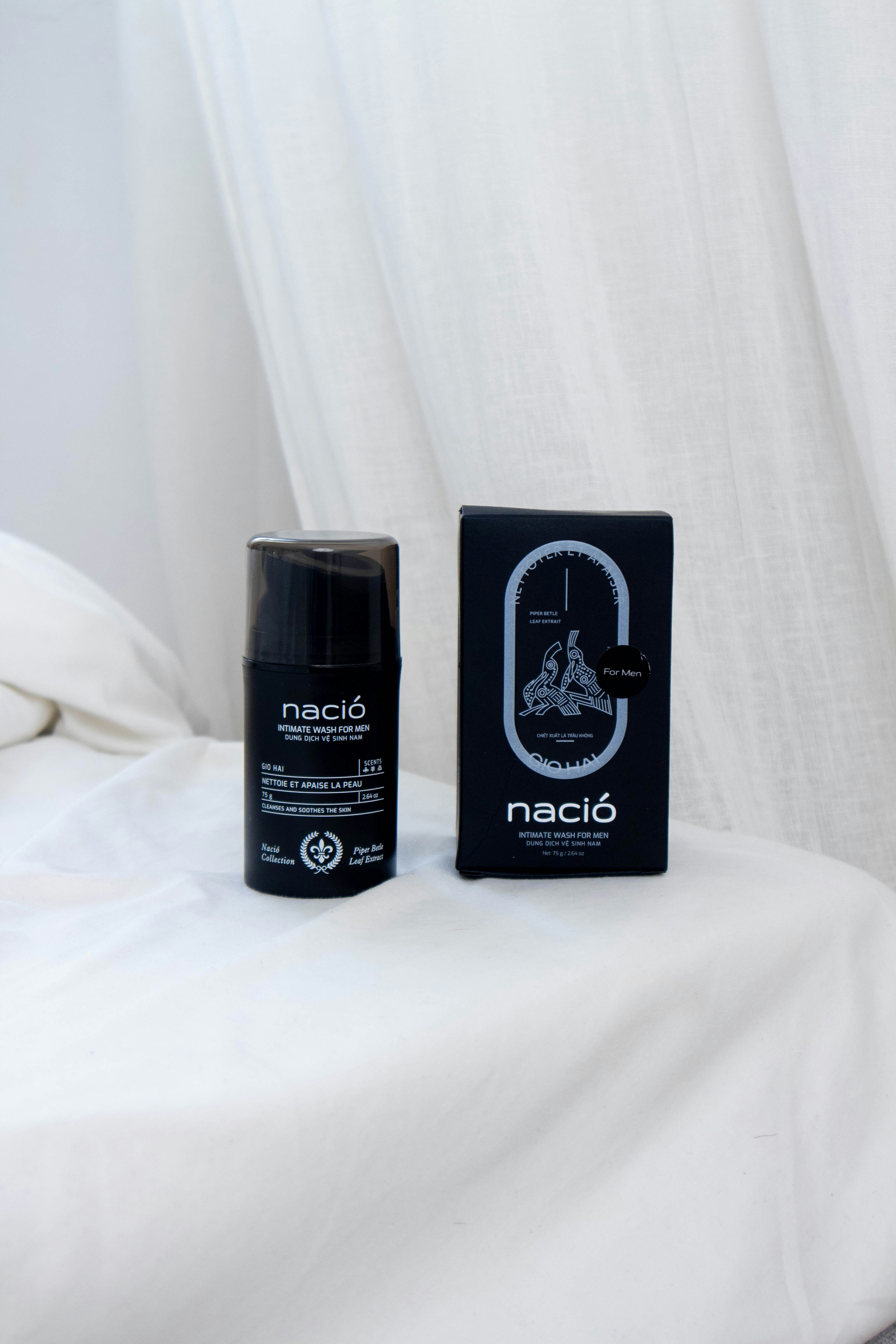Minimalist black duo: a male grooming bottle and its sleek box on a white surface