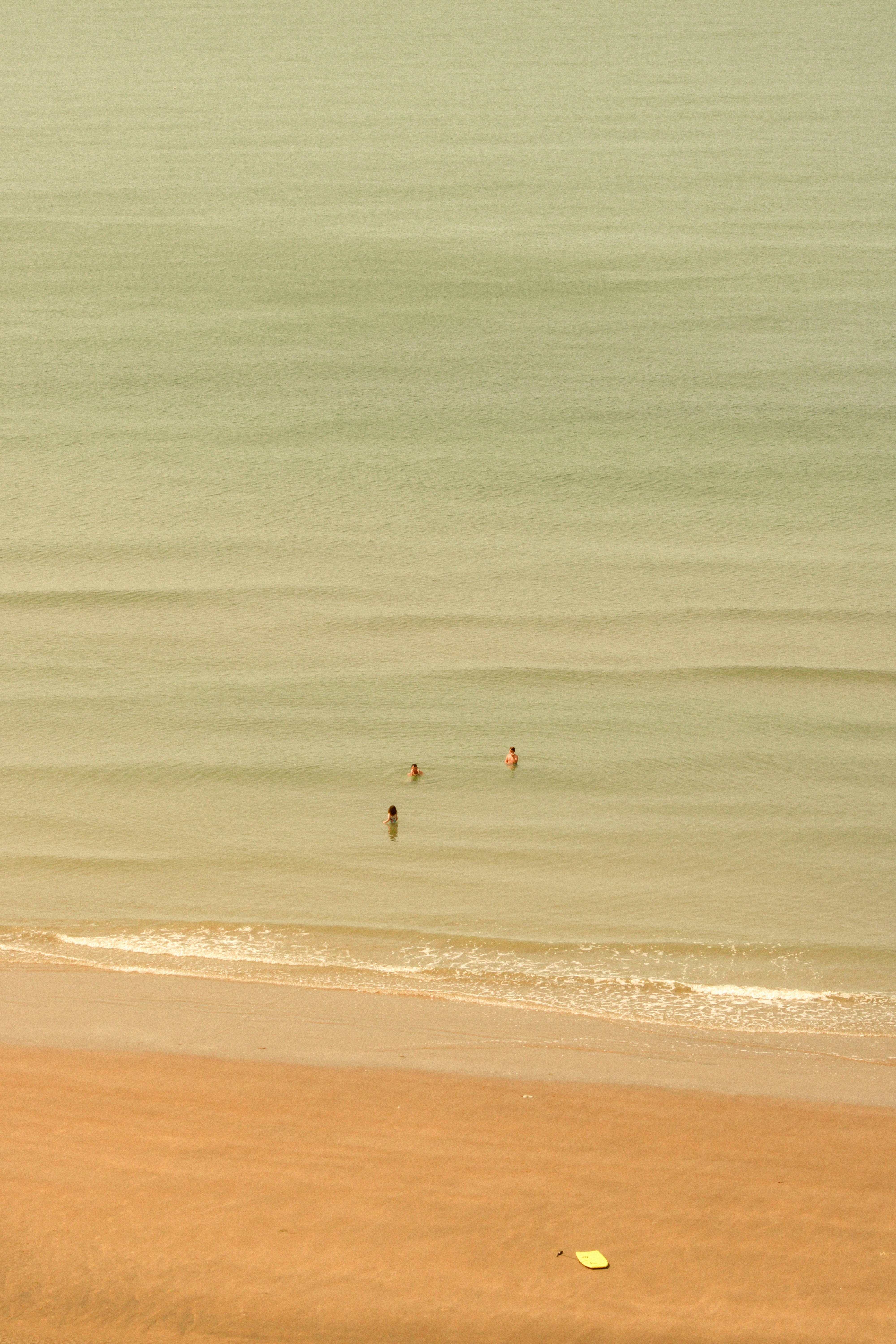 Muted Tide: Coastal Figures in Quiet Ocean Glass